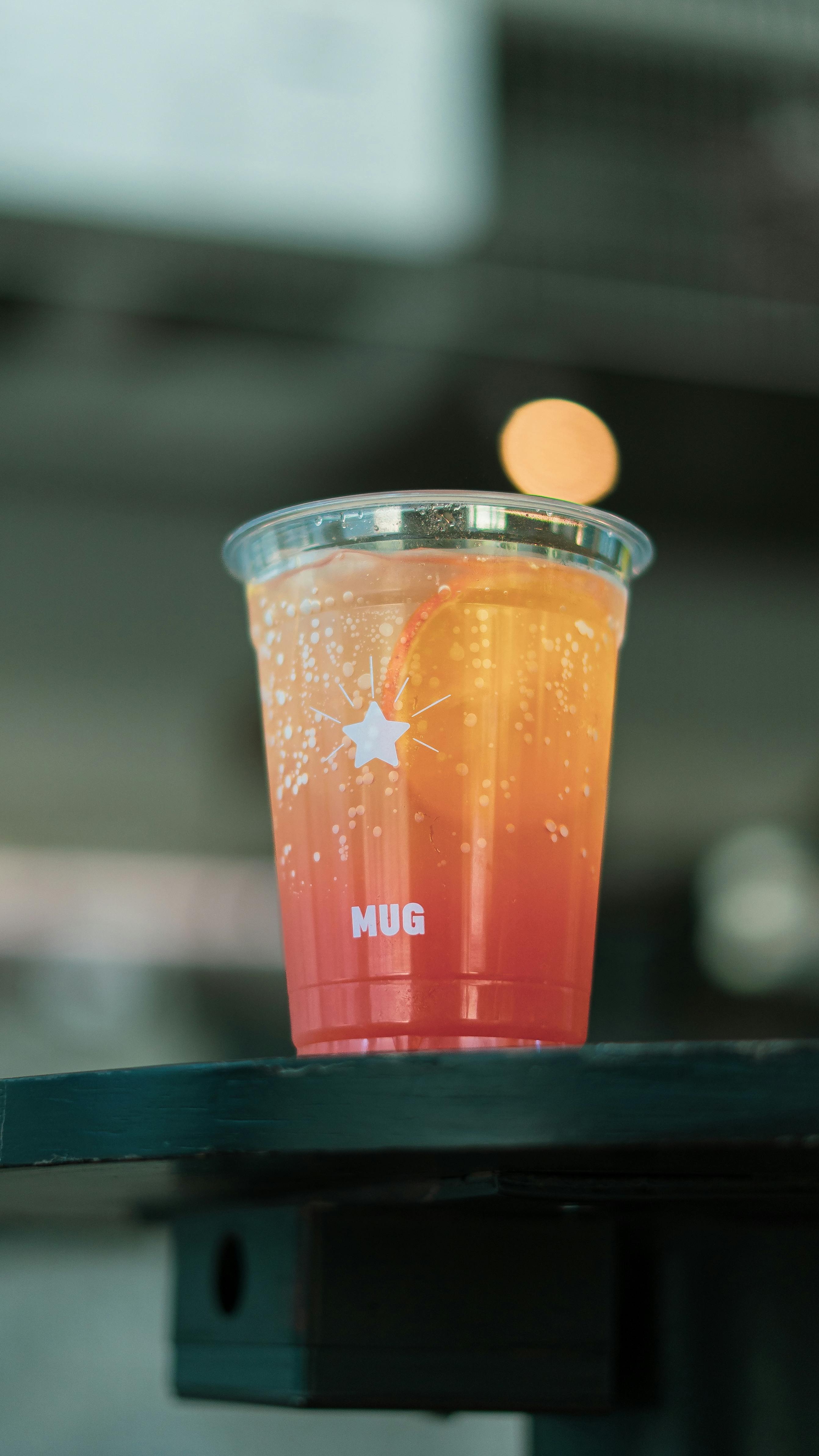 Orange Cold Drink in Disposable Cup · Free Stock Photo