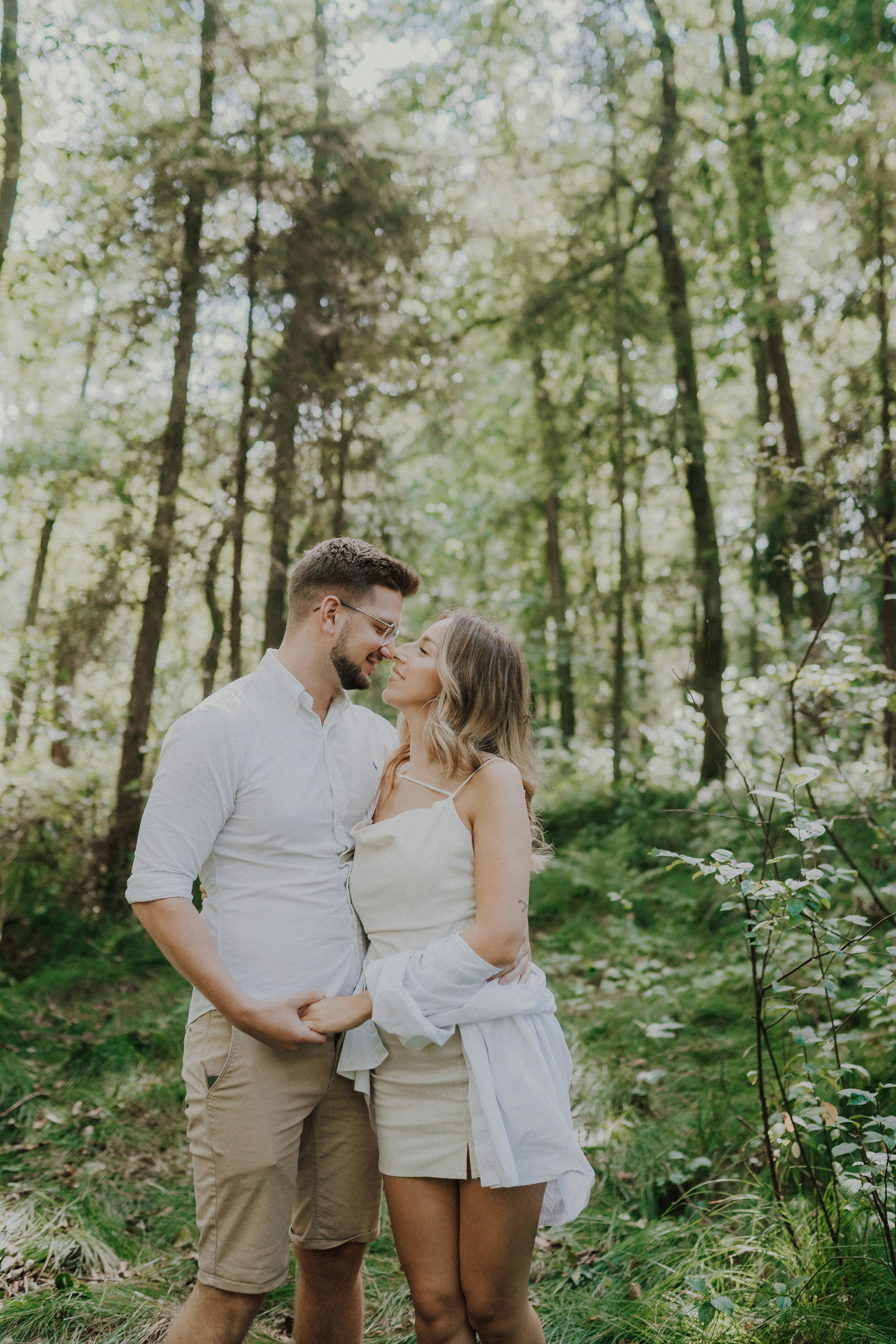 Young Couple Embracing in a Forest · Free Stock Photo