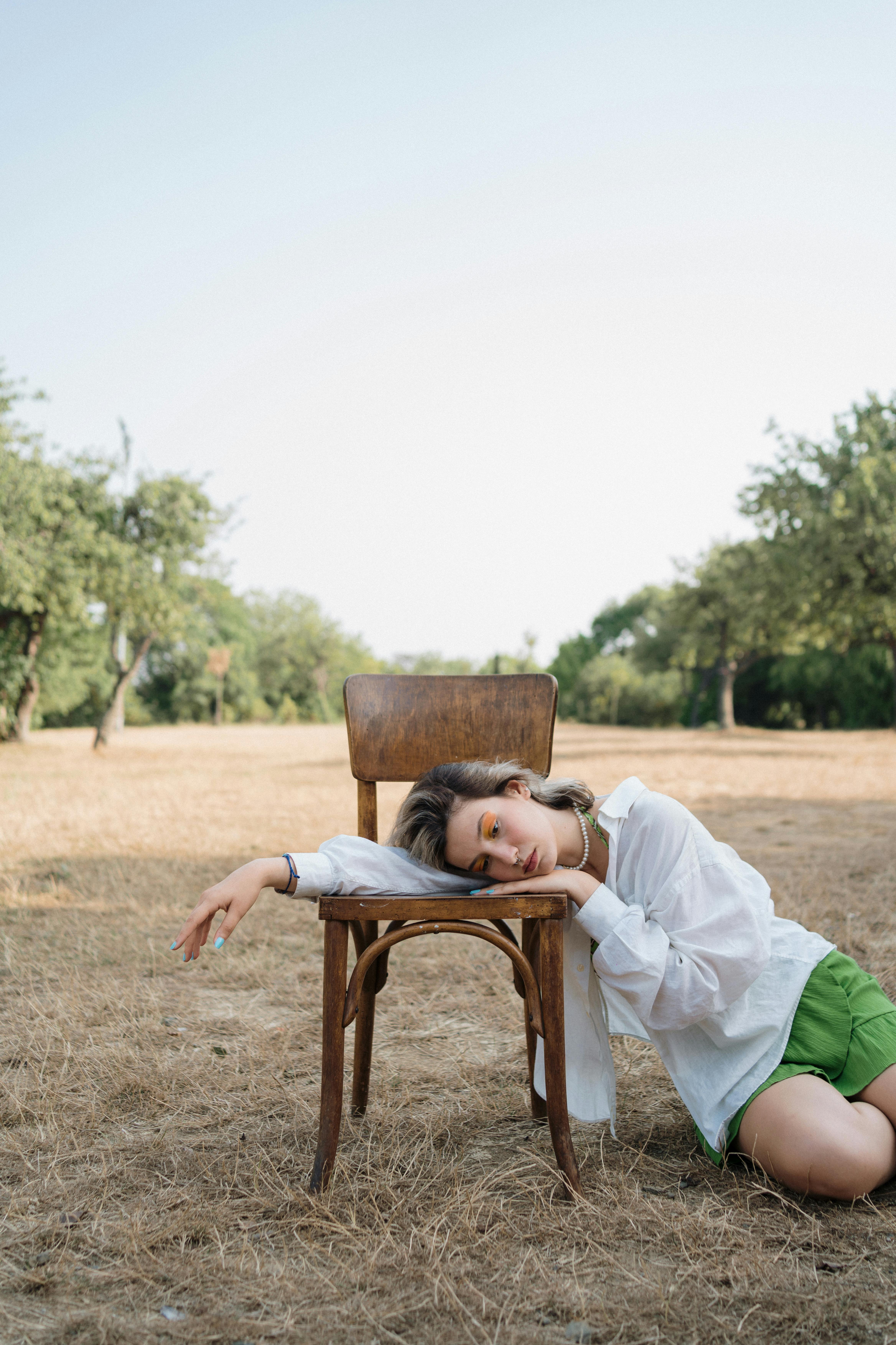 Woman Leaning on Chair · Free Stock Photo