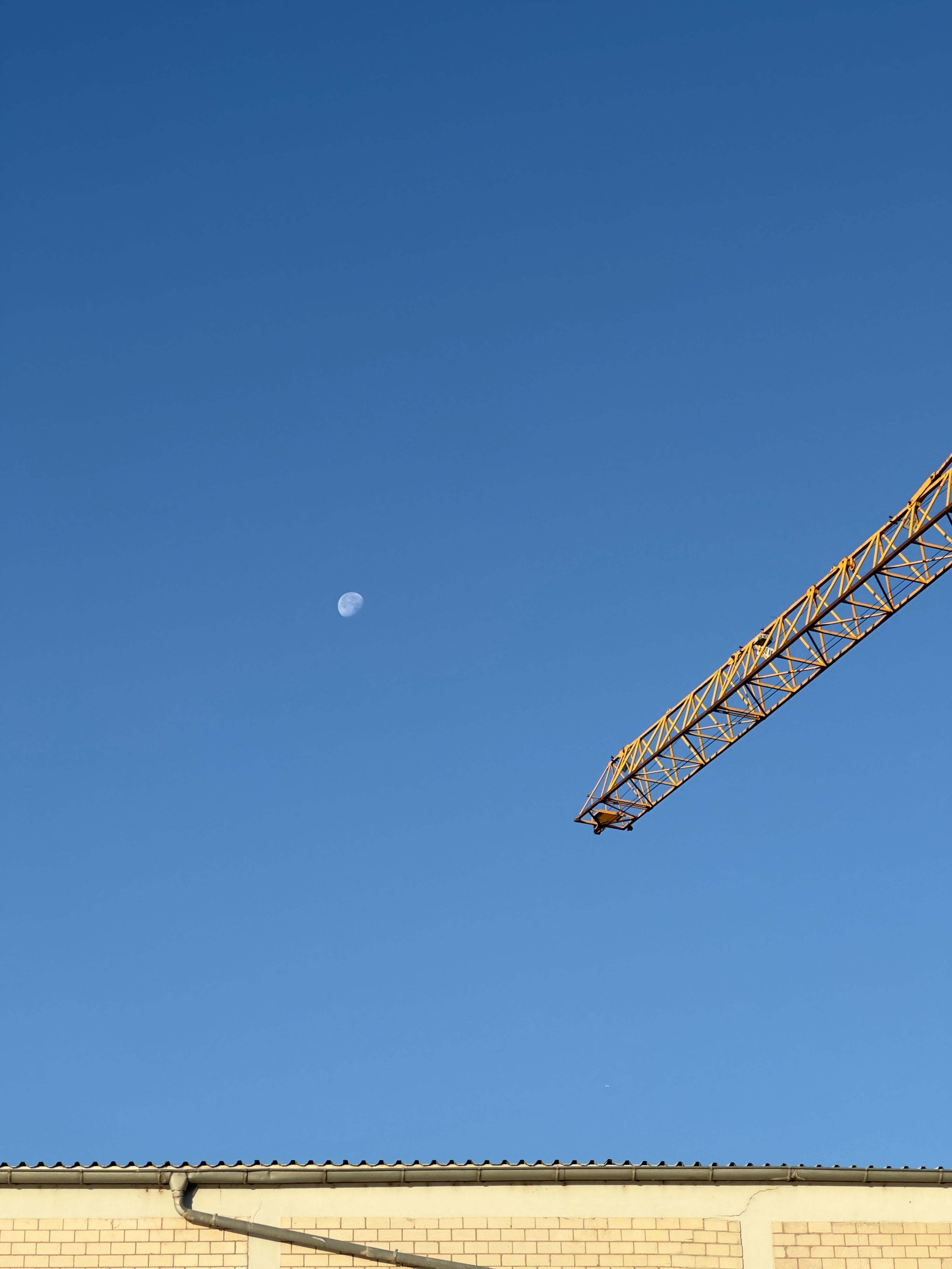 Full Moon over Crane and Stone Wall · Free Stock Photo