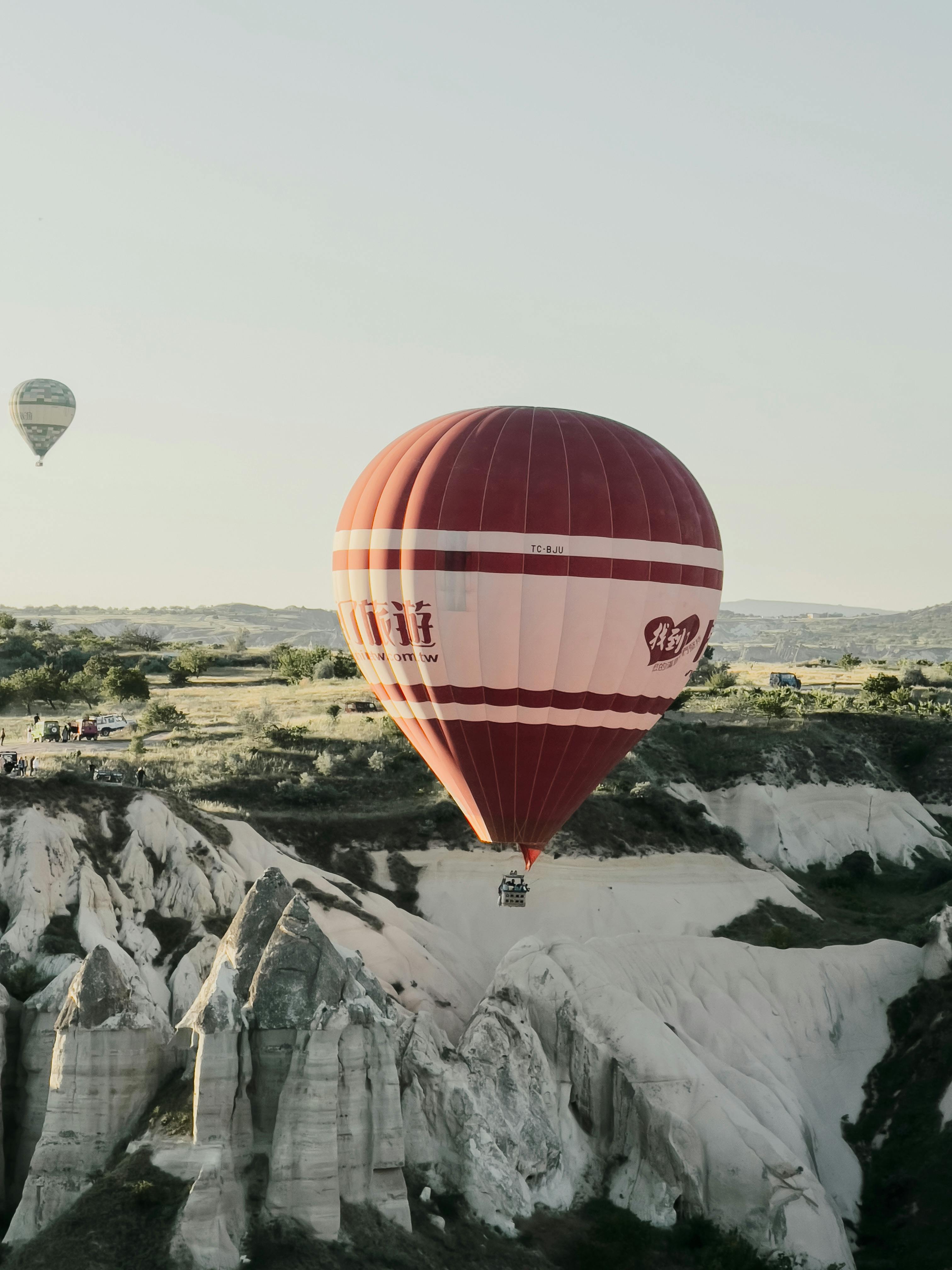 Multi Colored Balloon Floating over Cappadocia · Free Stock Photo