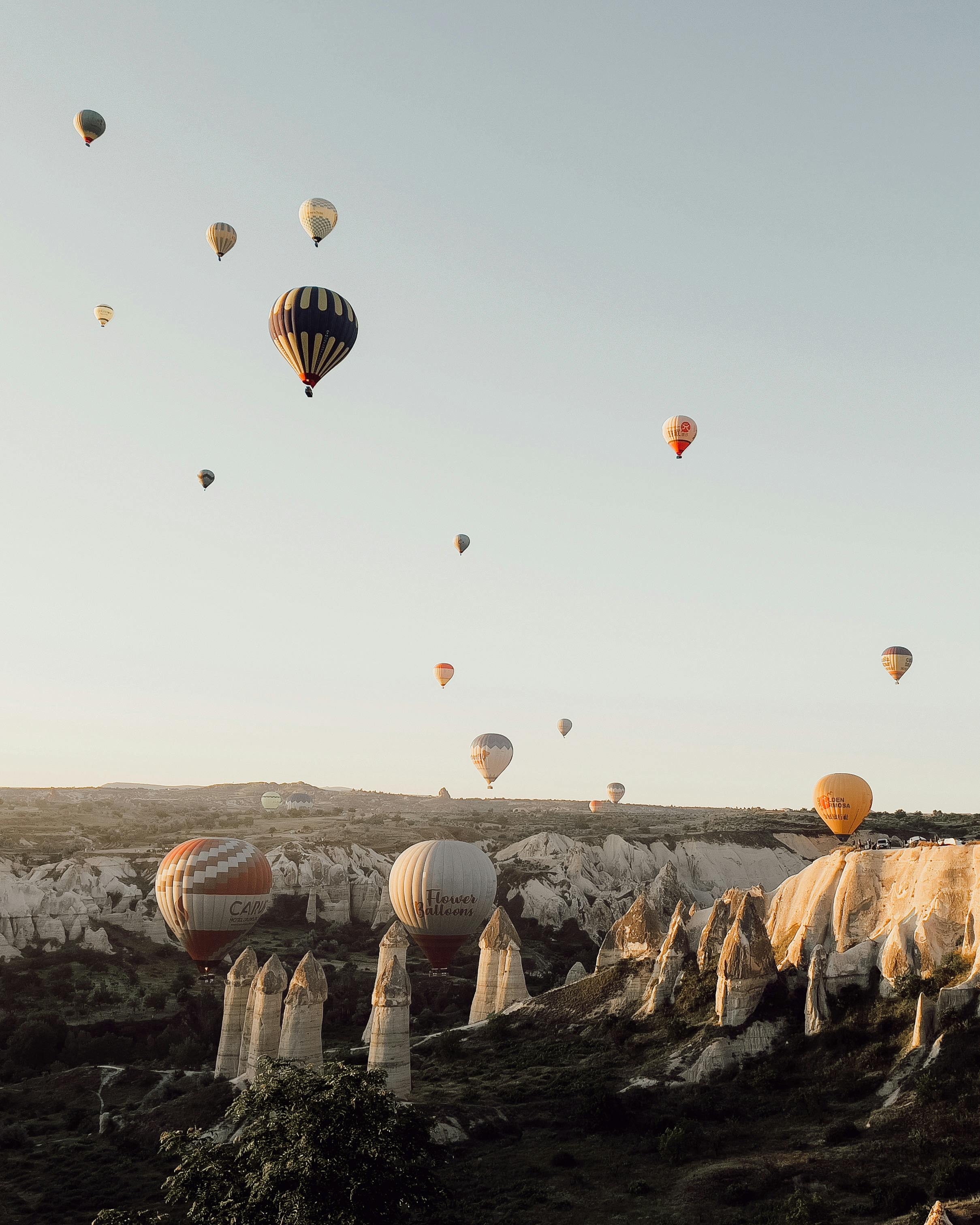 Hot-Air Balloons Flying over Rock Formations in Cappadocia, Turkey ...