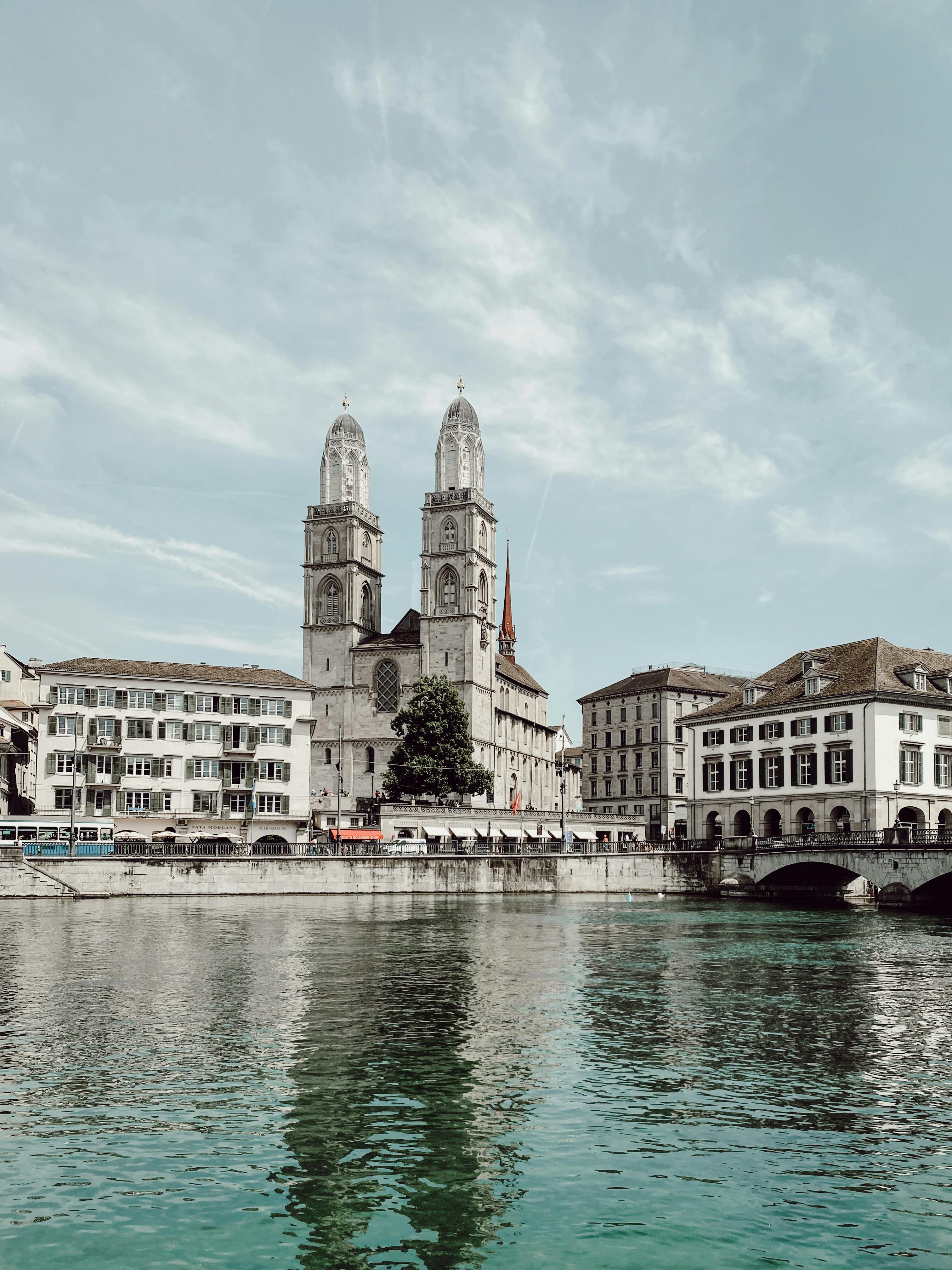 Grossmunster Church near River in Zurich · Free Stock Photo