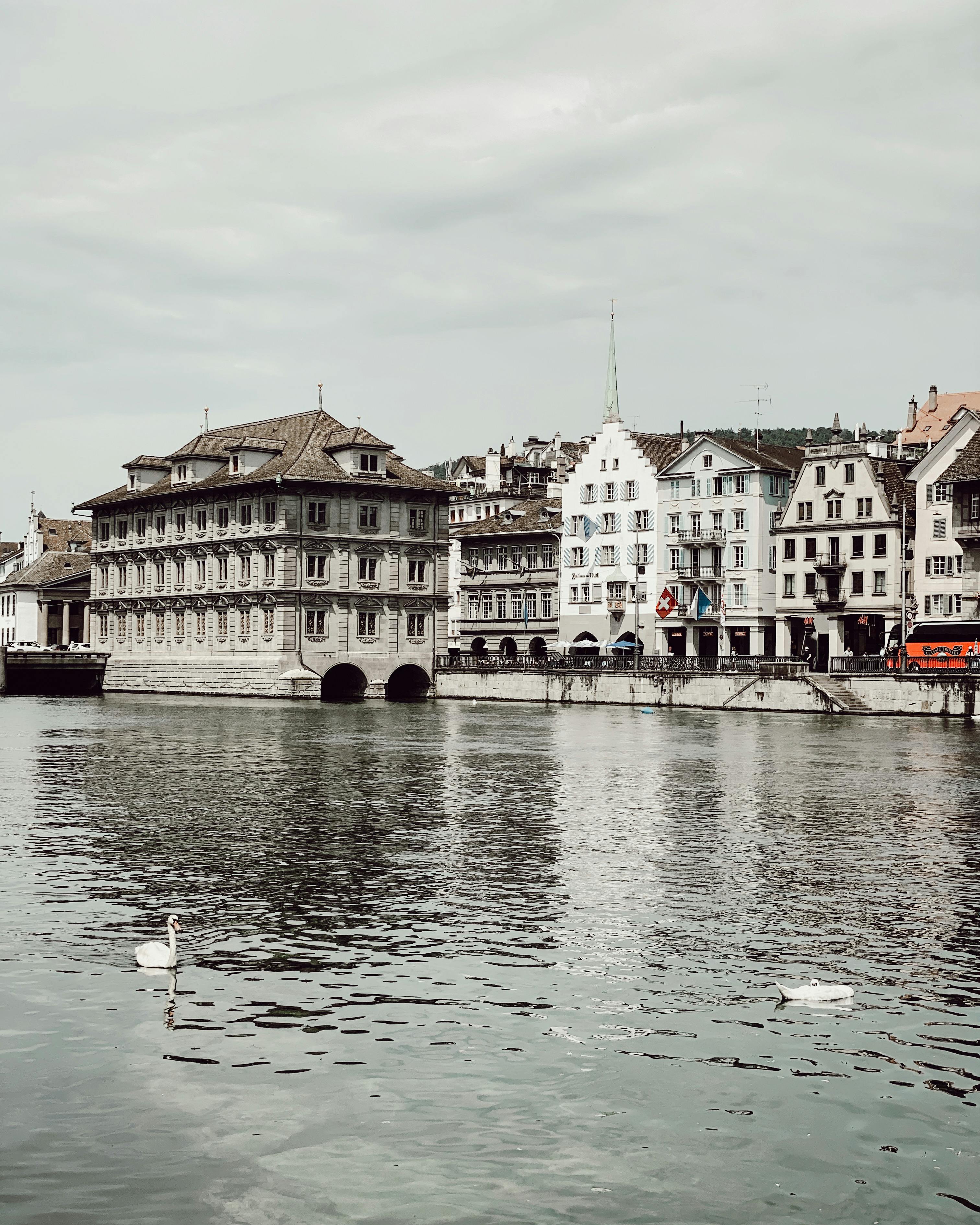 Grossmunster Church near River in Zurich · Free Stock Photo