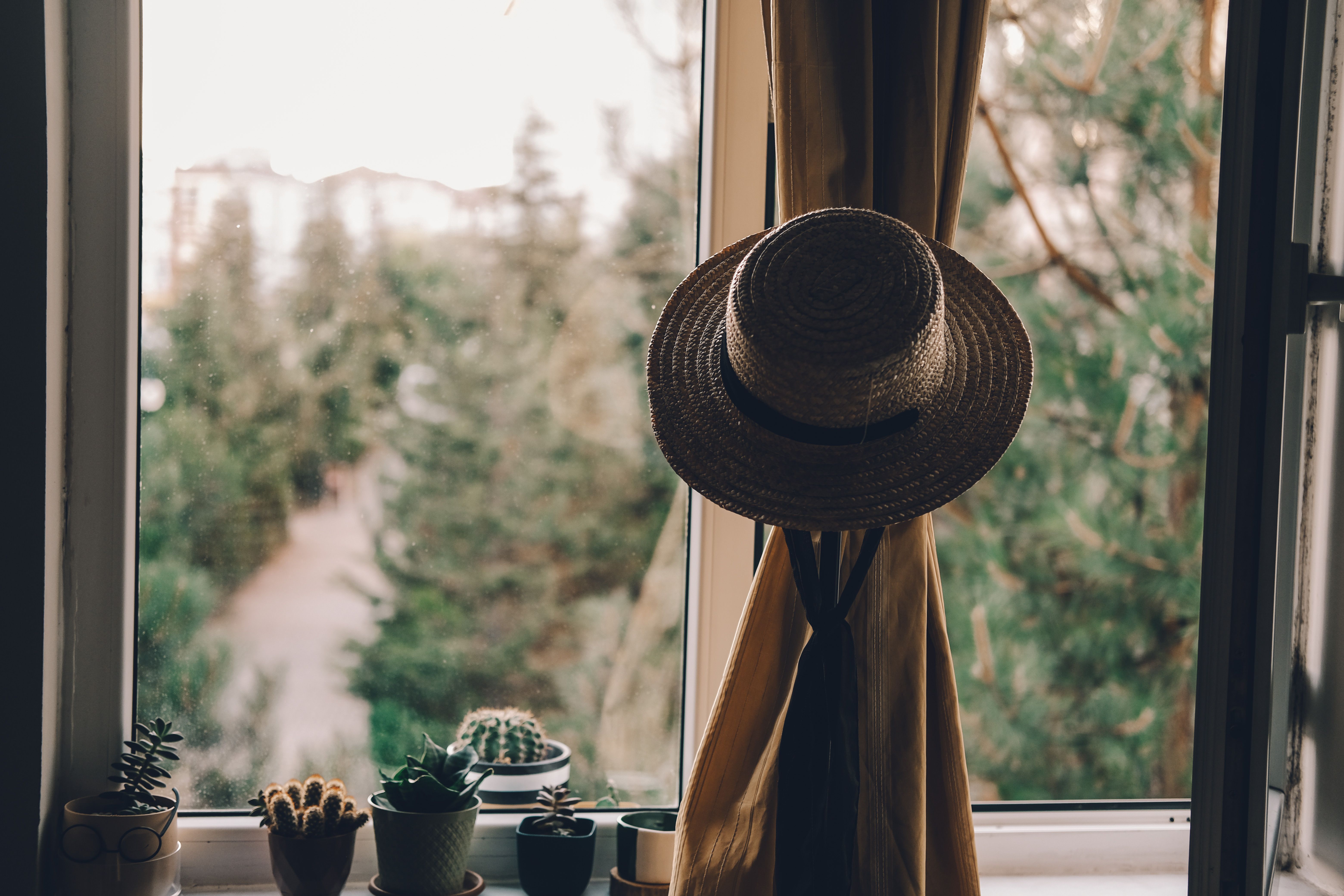 Straw Hat Hanging by the Window · Free Stock Photo