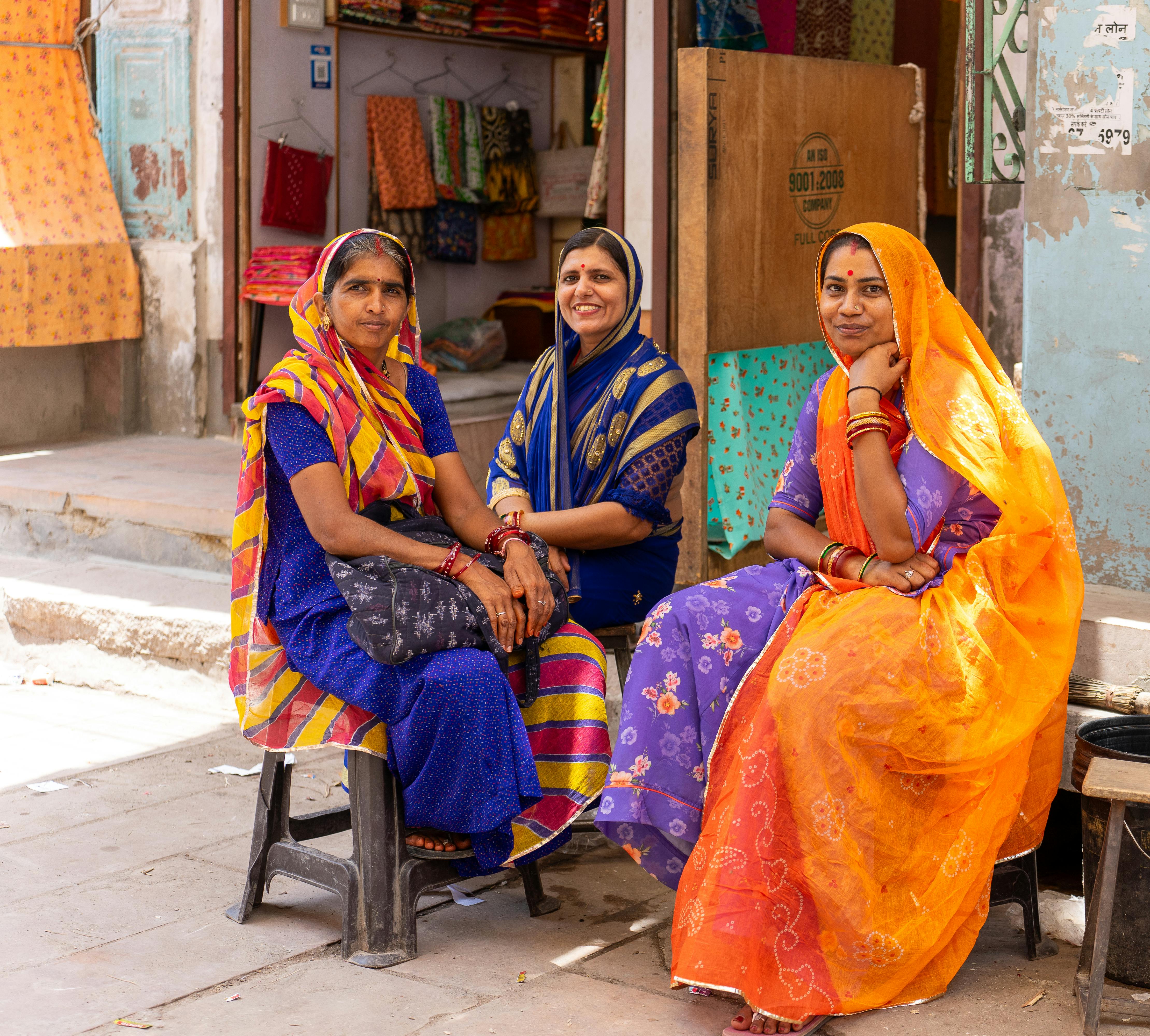 Women in Traditional Indian Clothes Sitting in Front of the Store ...