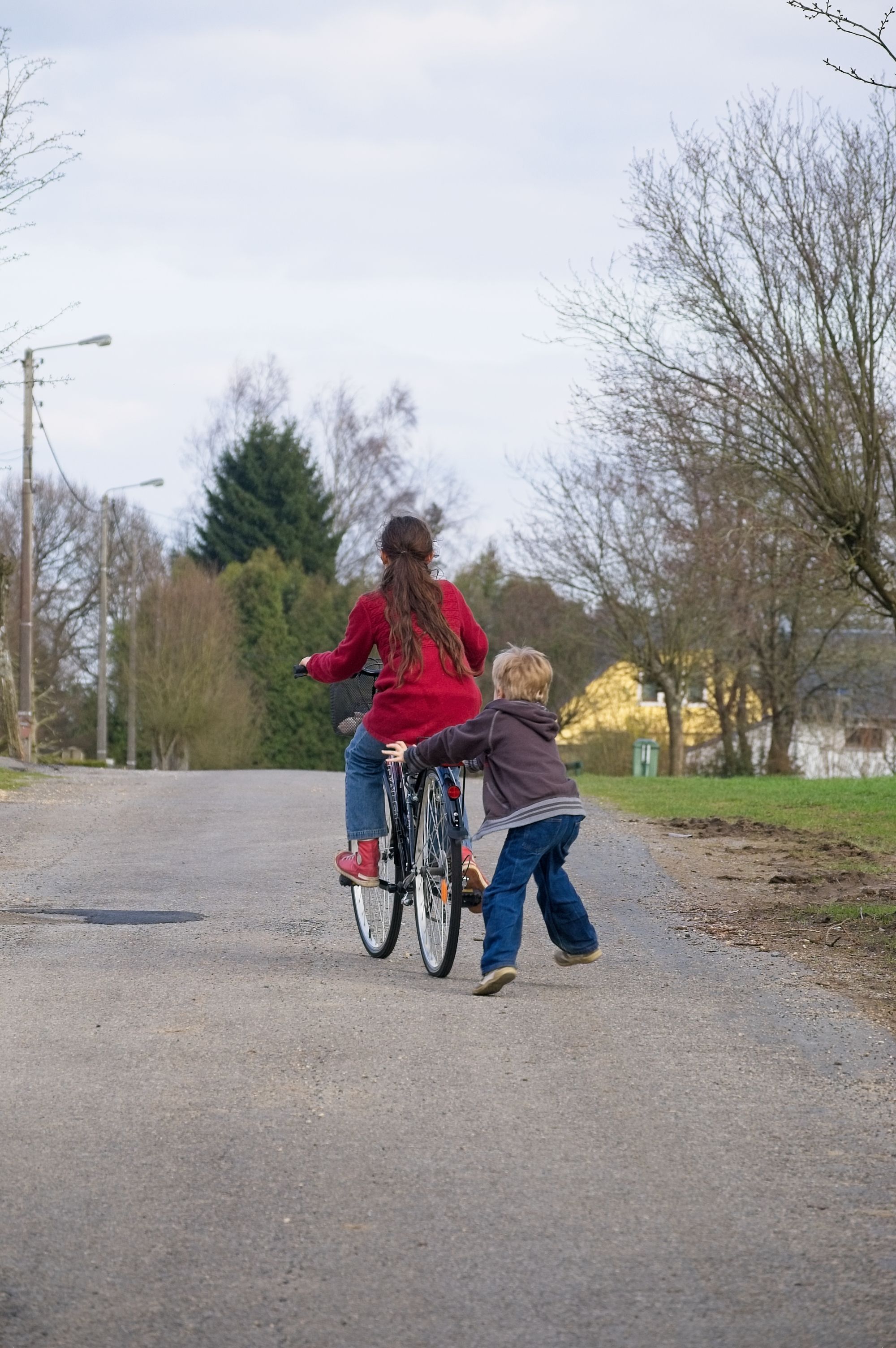 Boy Pushing Girl on Bicycle · Free Stock Photo