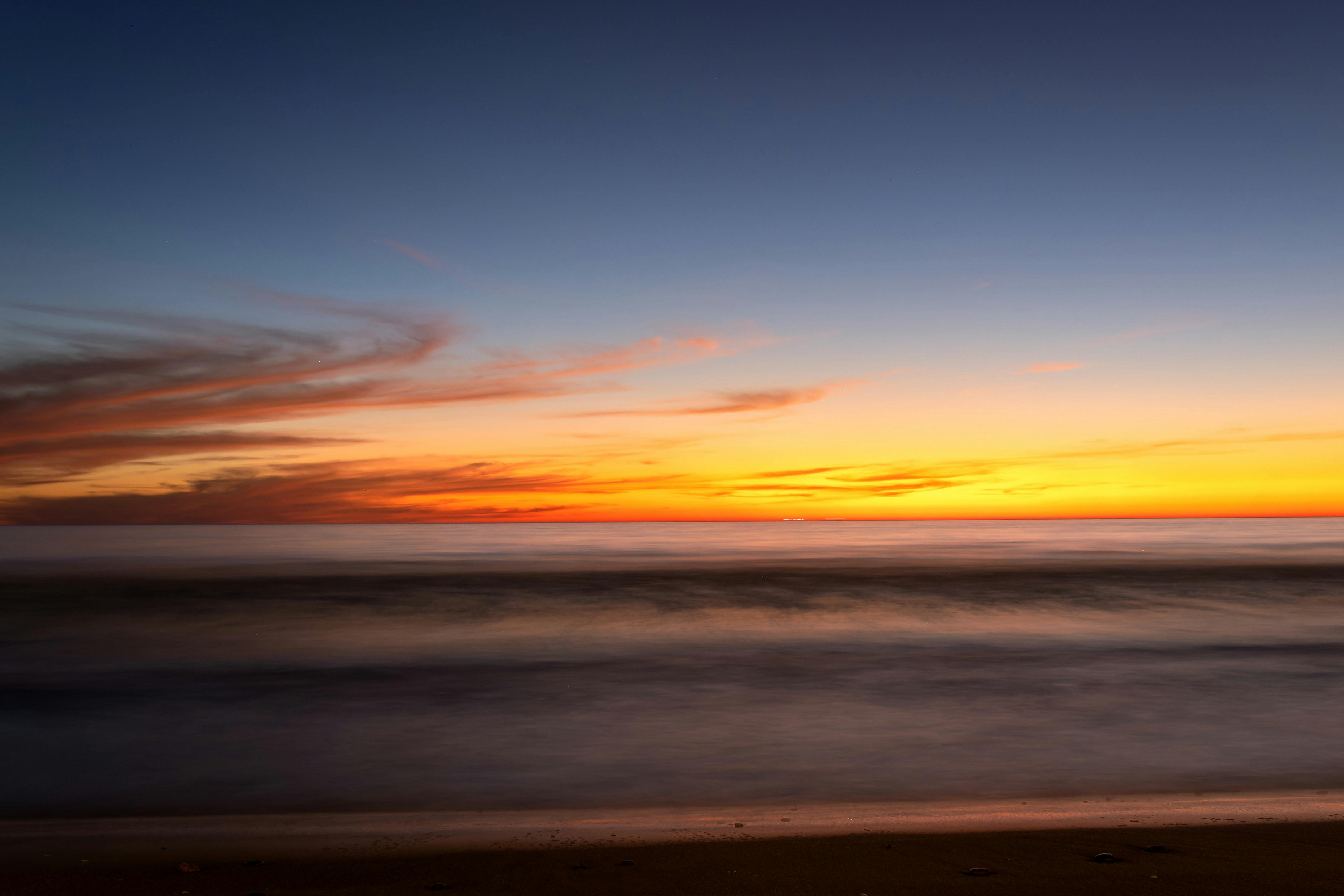 Red Sky over Sea Shore at Sunset · Free Stock Photo