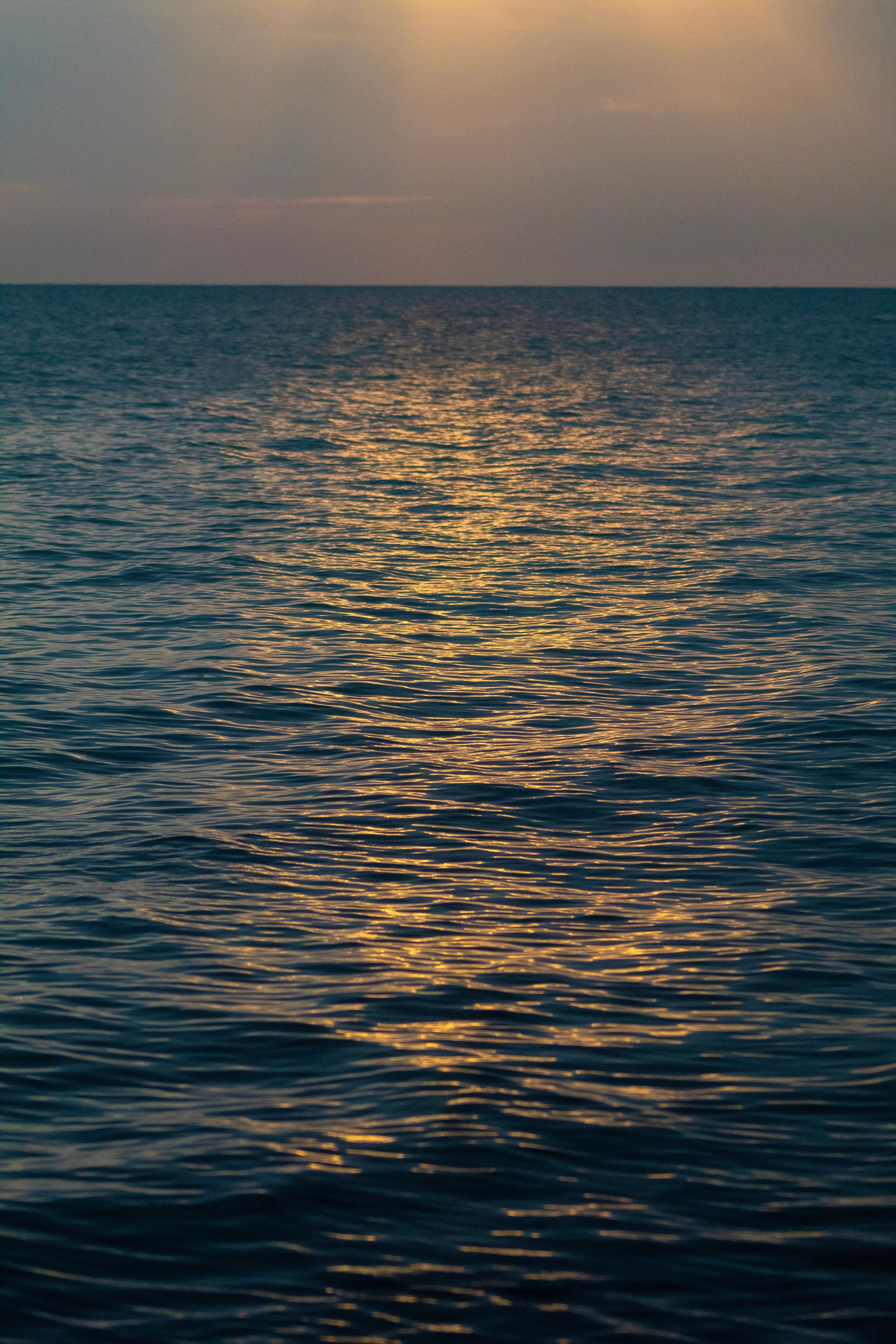 Blue Sea Water Reflecting Golden Sunset Light · Free Stock Photo