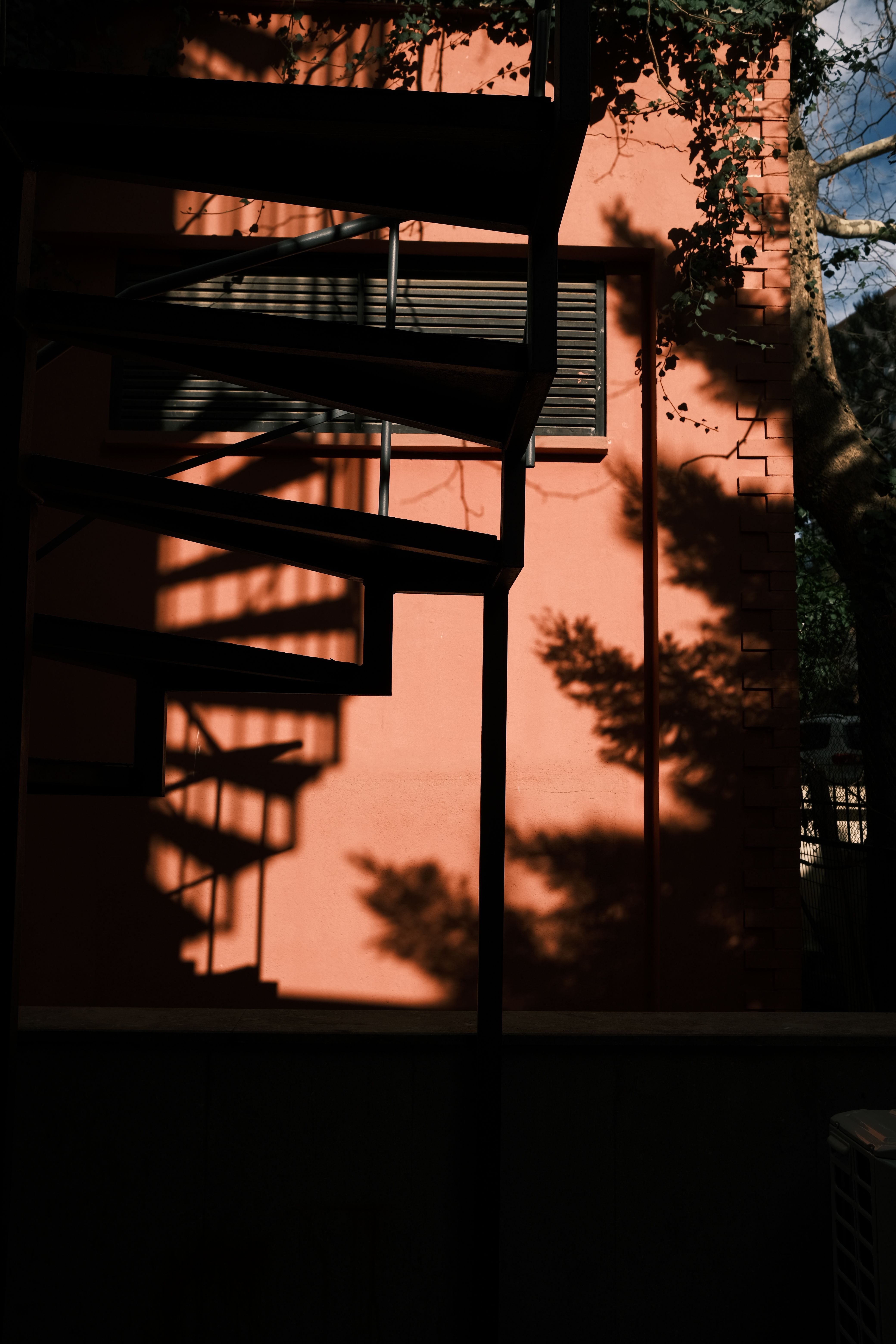 Shadows on Sunlit Building Wall · Free Stock Photo