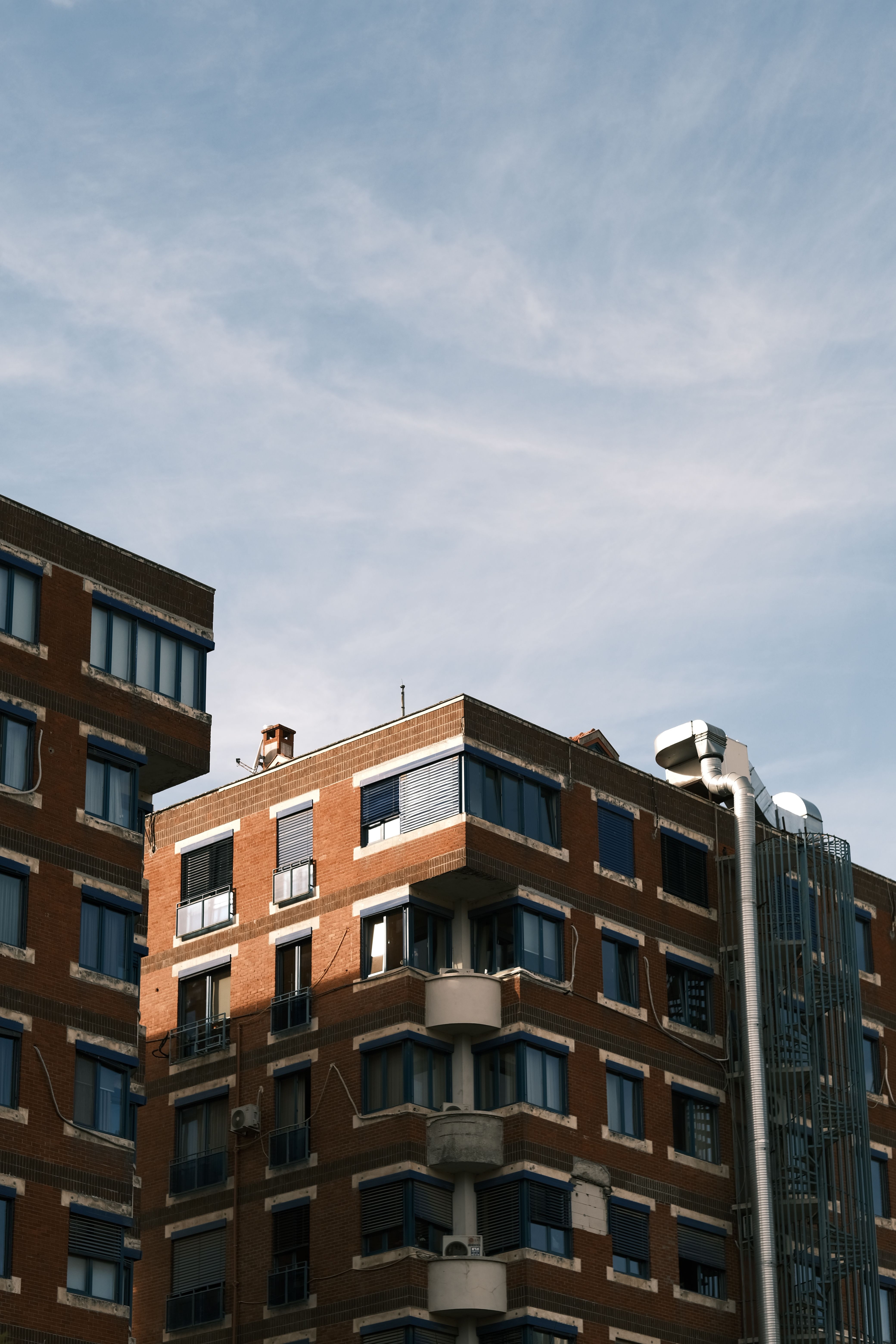 Red Lights on the Windows of an Apartment Building · Free Stock Photo