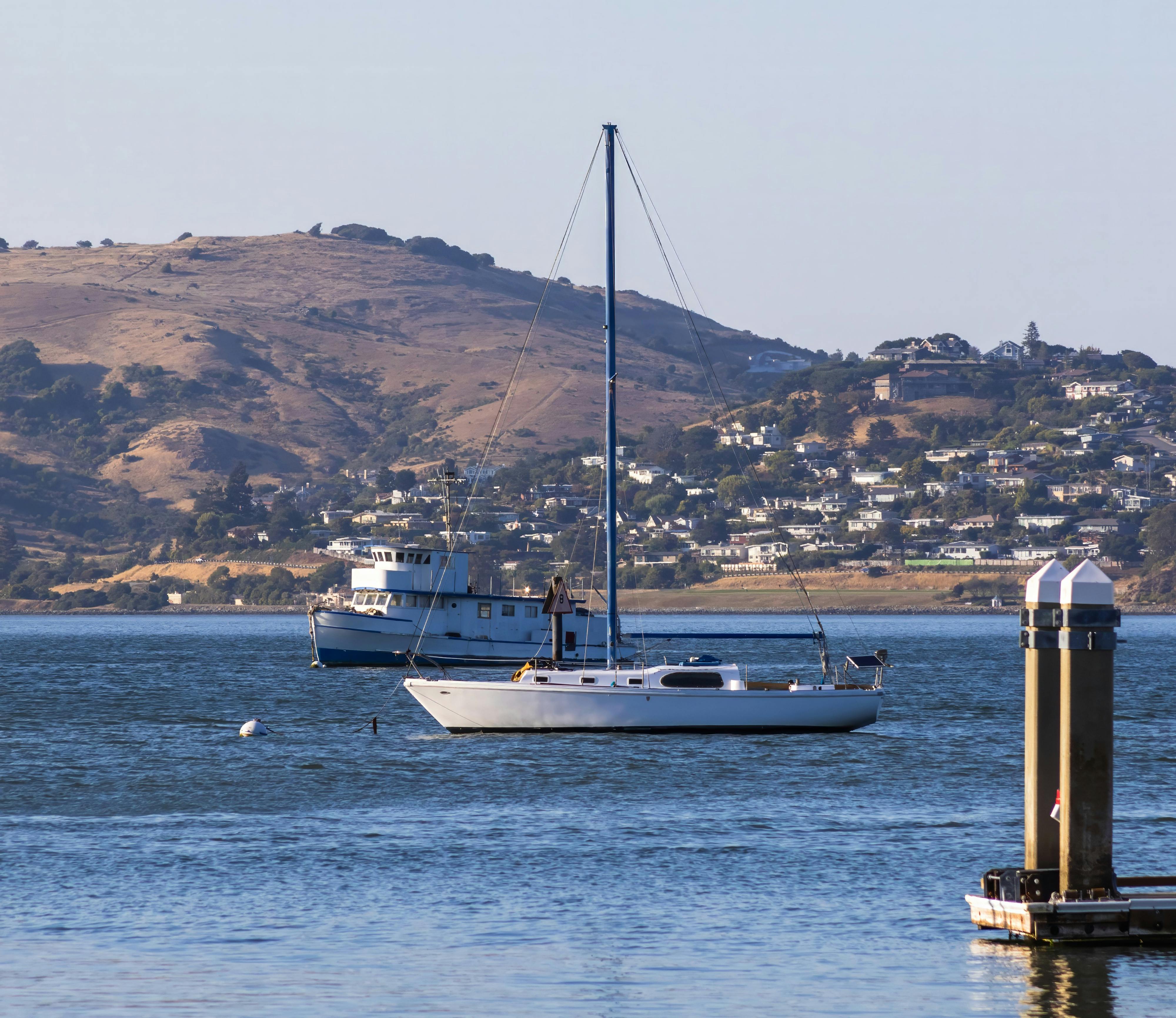 Sailboat Anchored by Hills · Free Stock Photo