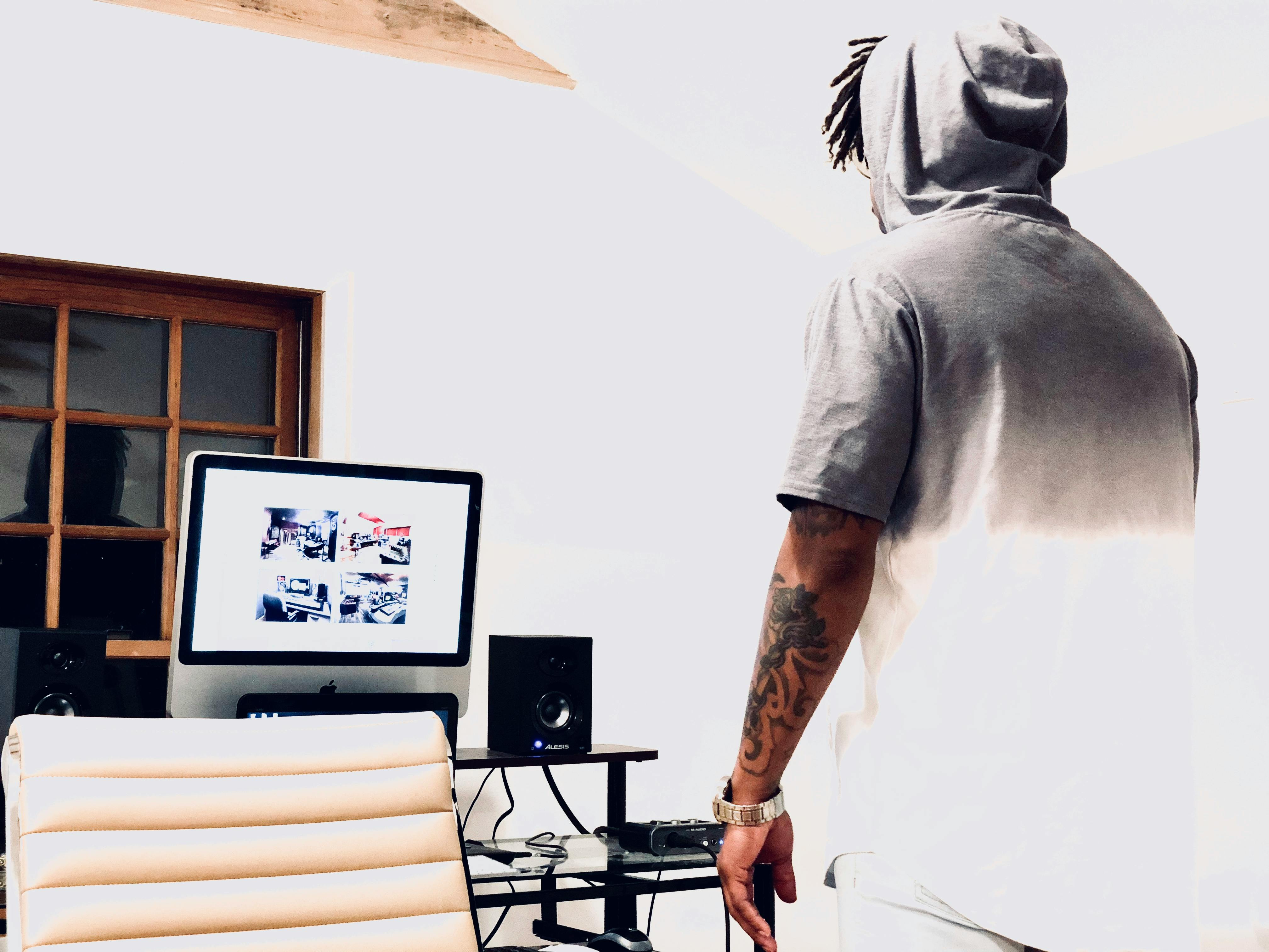 Man Standing Near Computer · Free Stock Photo