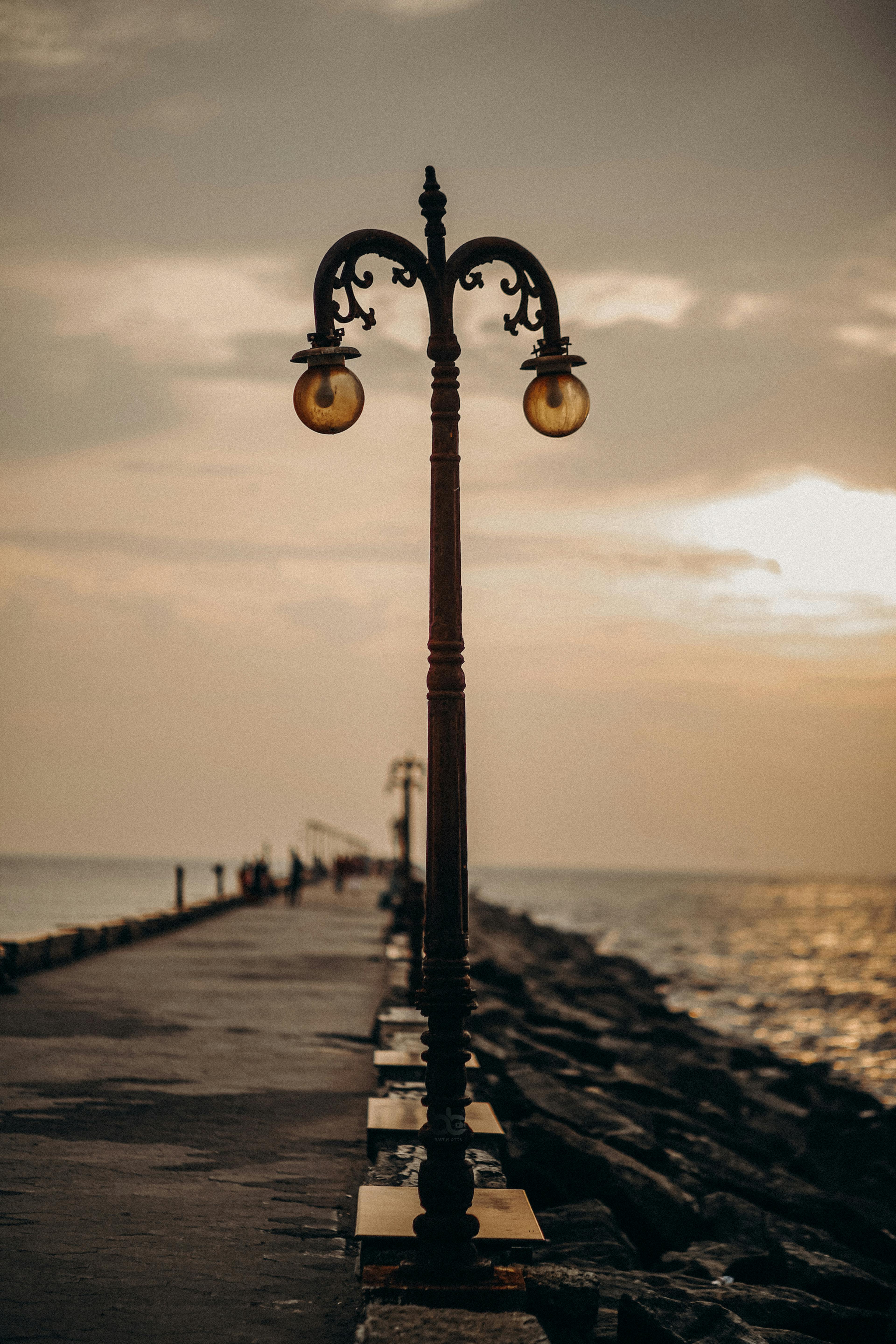 Wooden Dock on Sea Shore With Light Post during Sunset · Free Stock Photo
