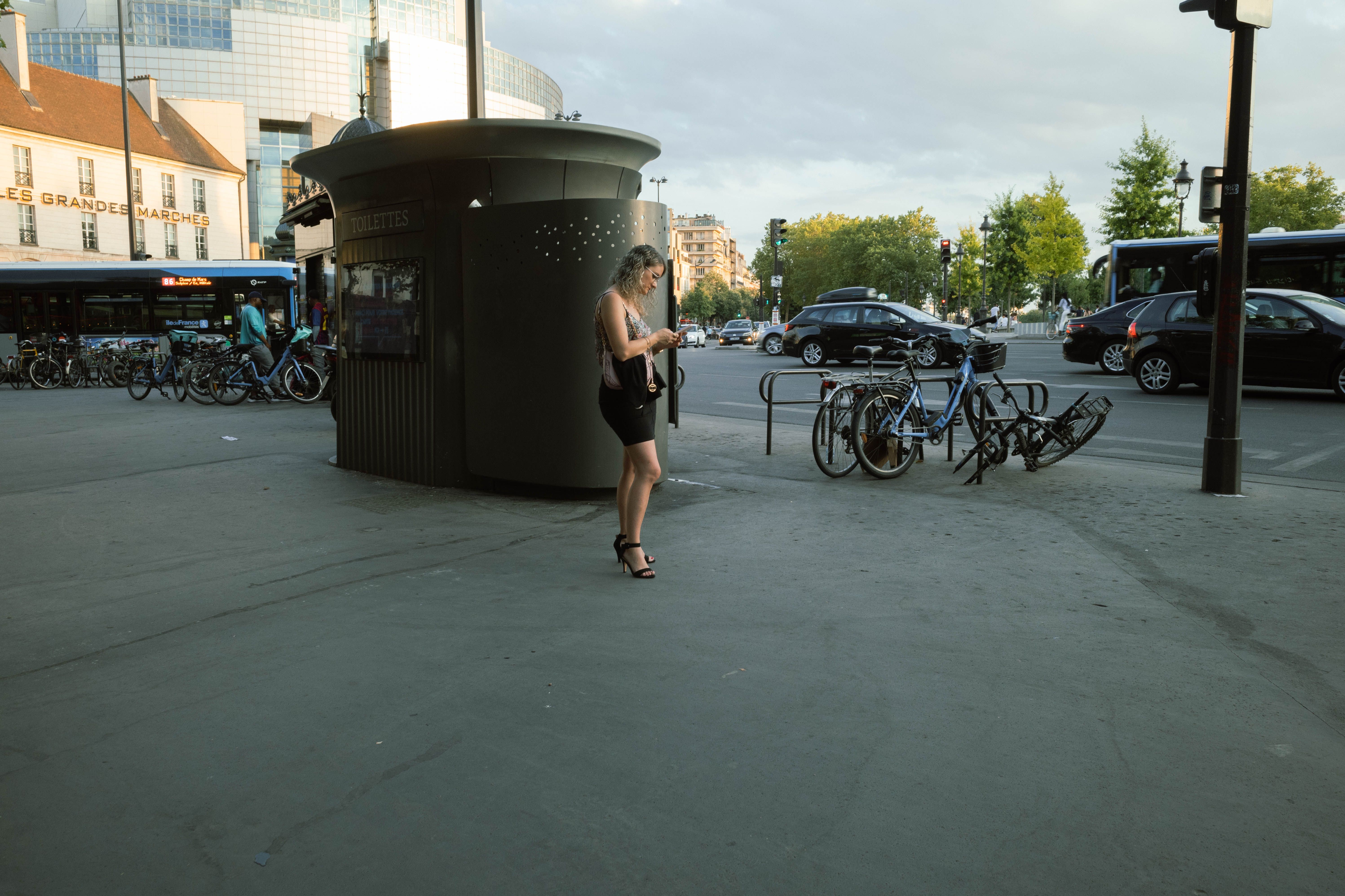 Woman Standing on Pavement near Street in City · Free Stock Photo
