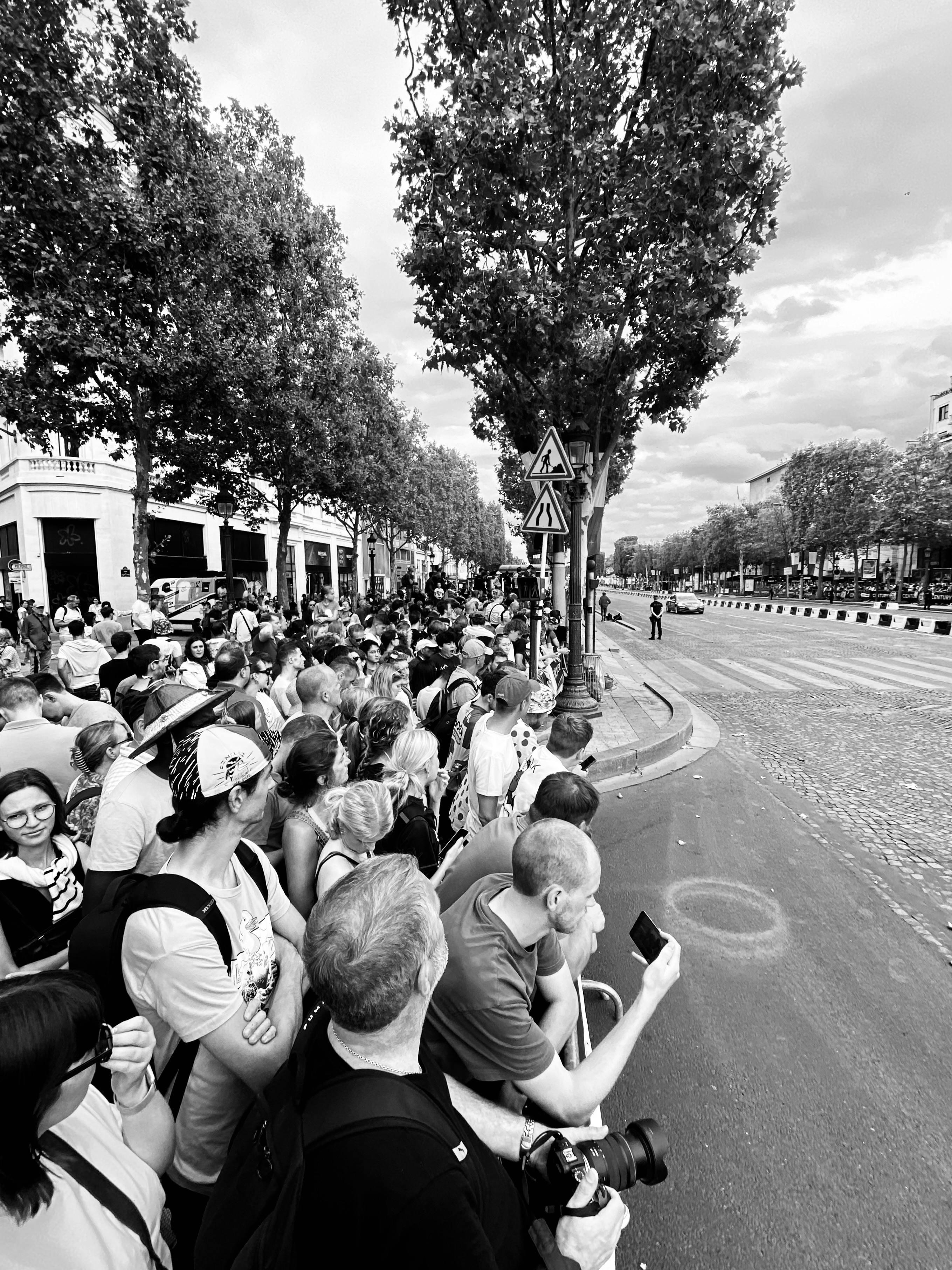 Crowd of People Standing along an Empty Street · Free Stock Photo