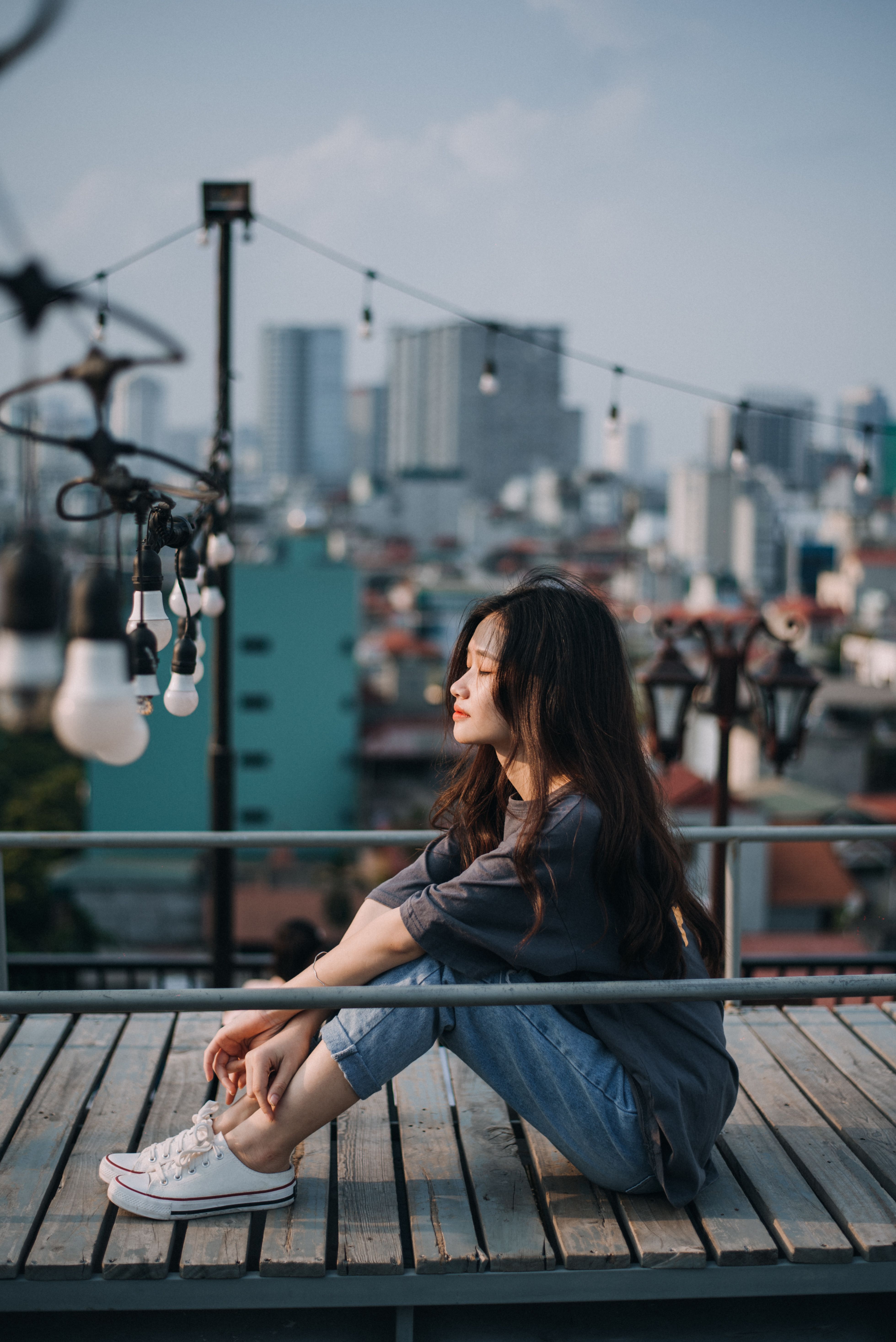 Woman Sitting on Top of Building's Edge · Free Stock Photo