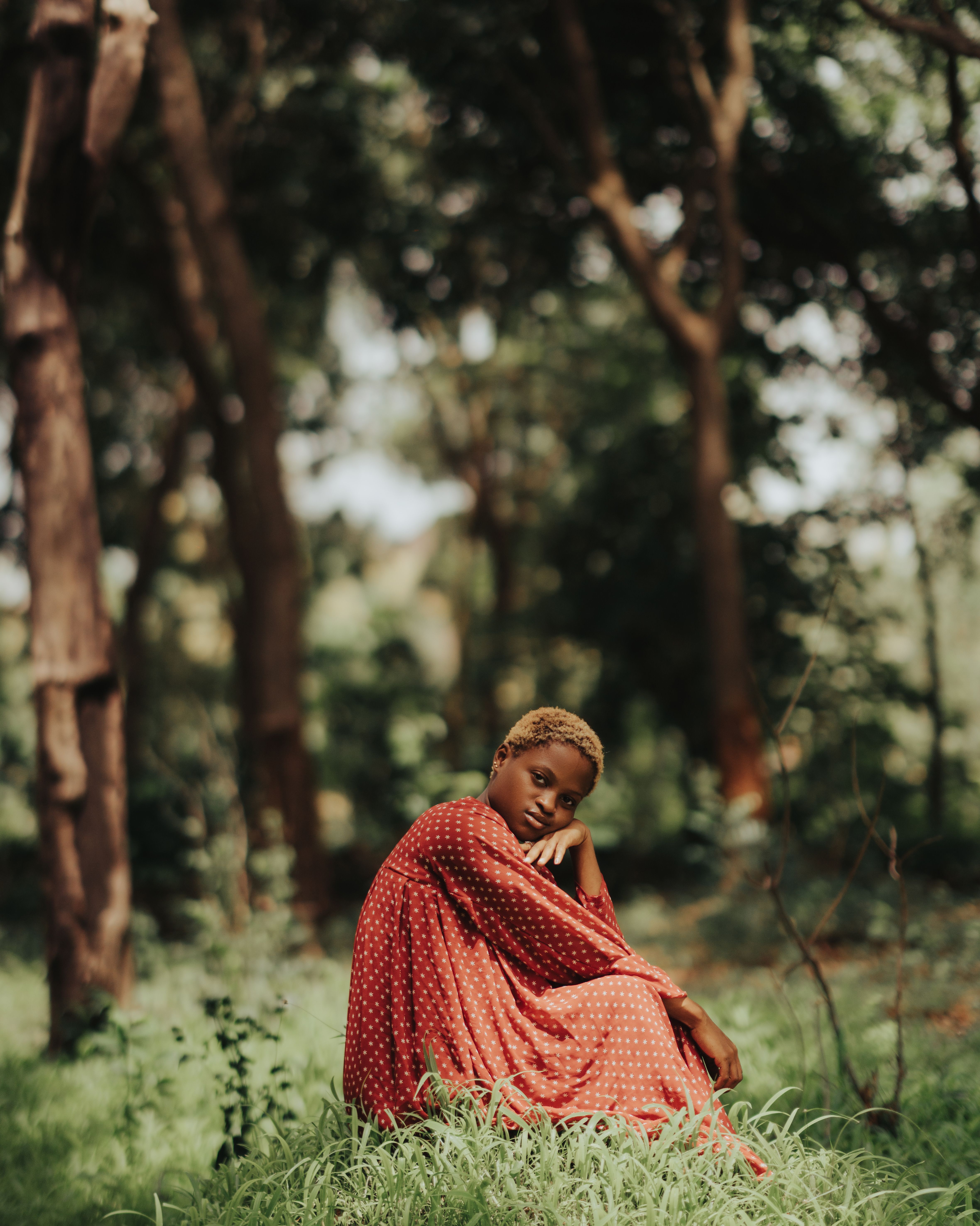 Woman in Red Spotted Dress Sitting in Forest · Free Stock Photo