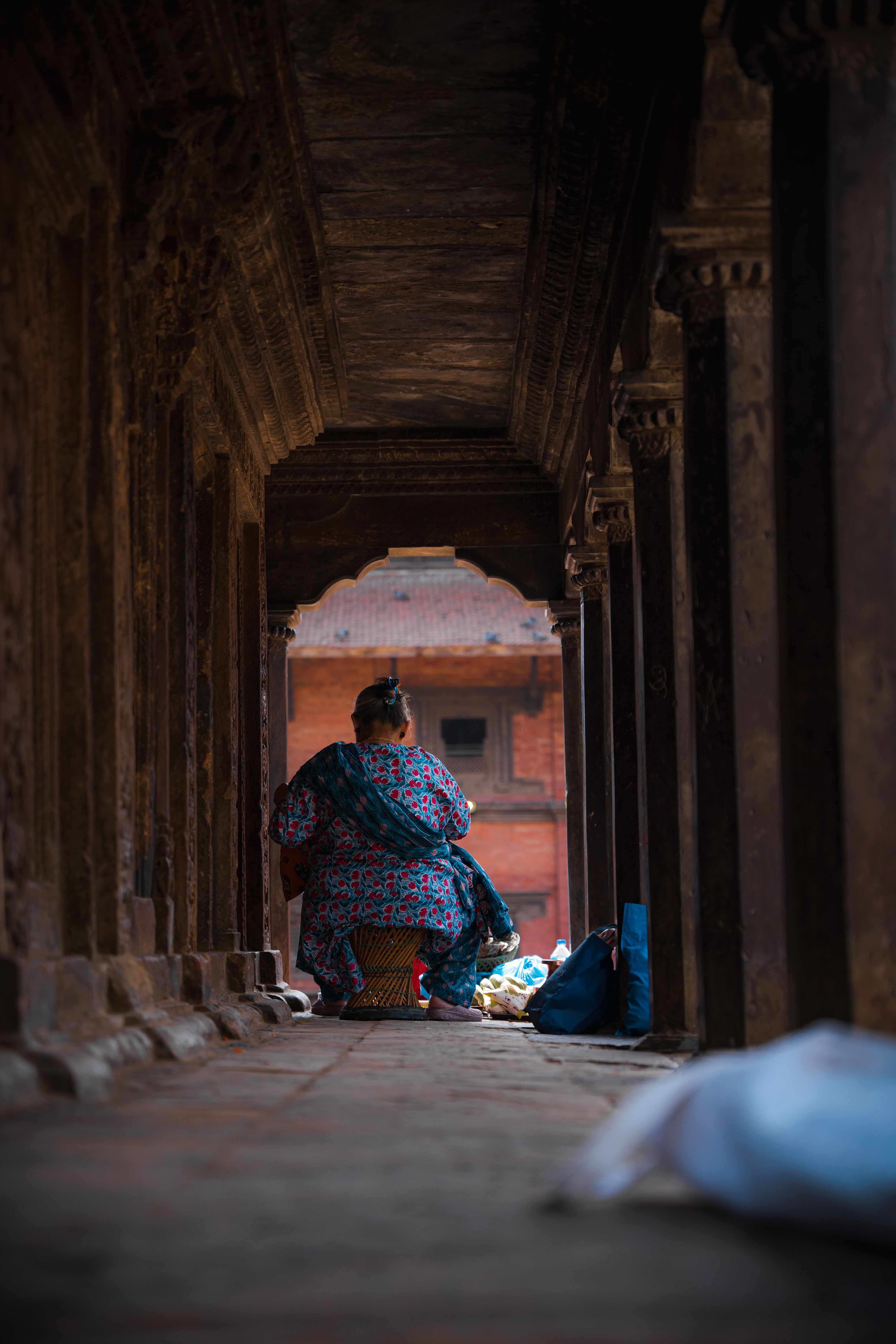 Woman Sitting under Archway · Free Stock Photo