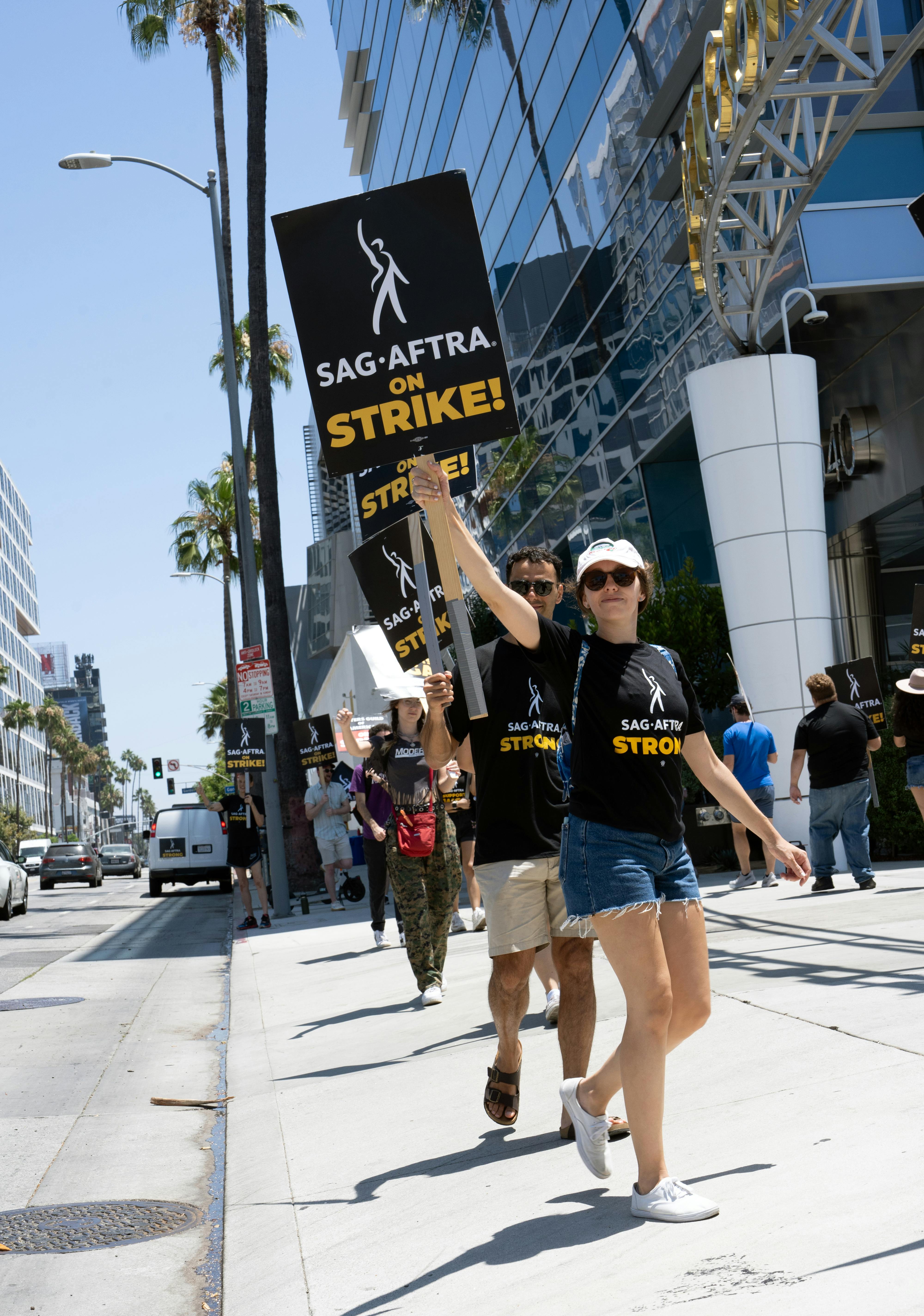 People Walking with Banners on Sidewalk in City · Free Stock Photo