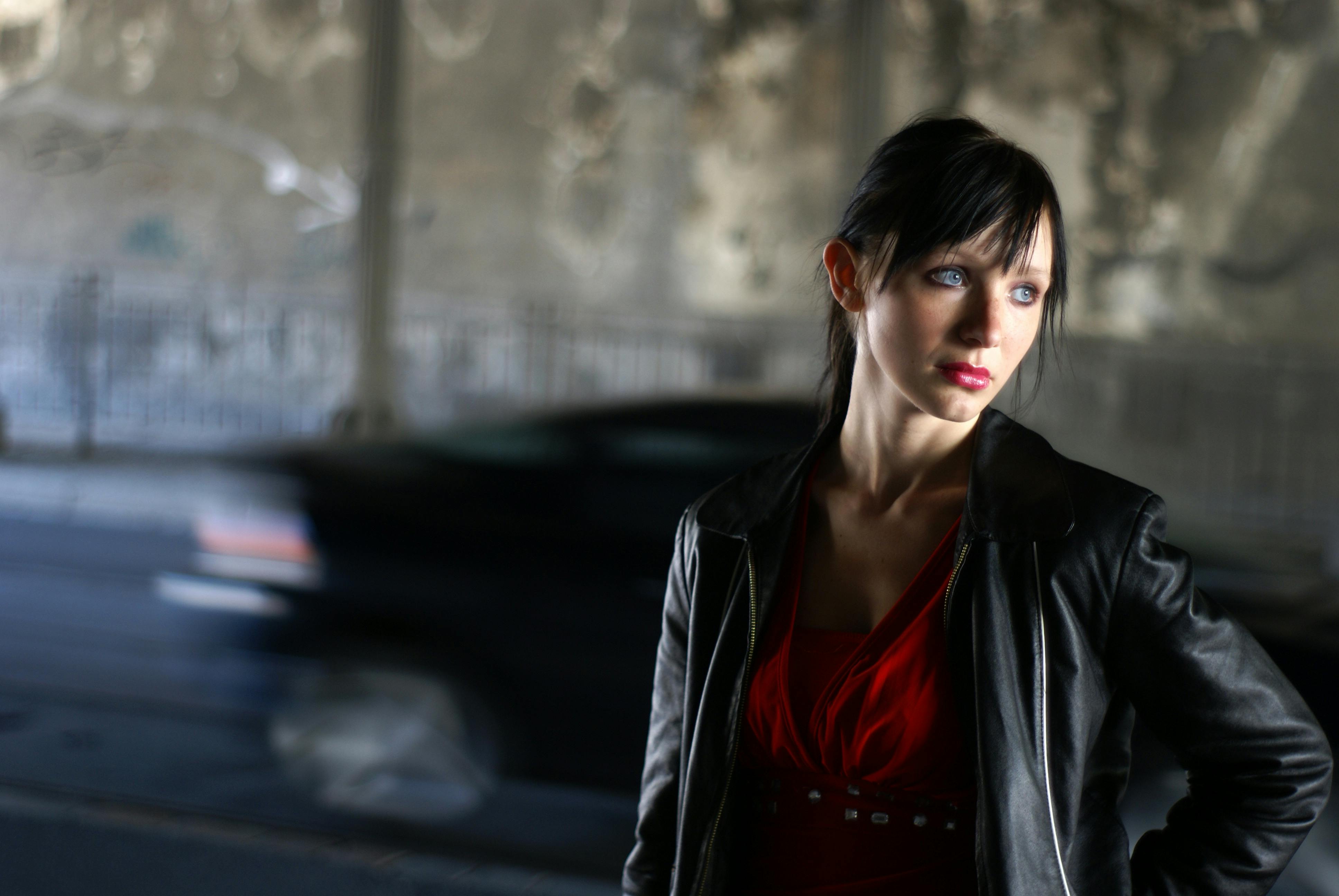 Photo of Woman Standing Near Road Sign · Free Stock Photo