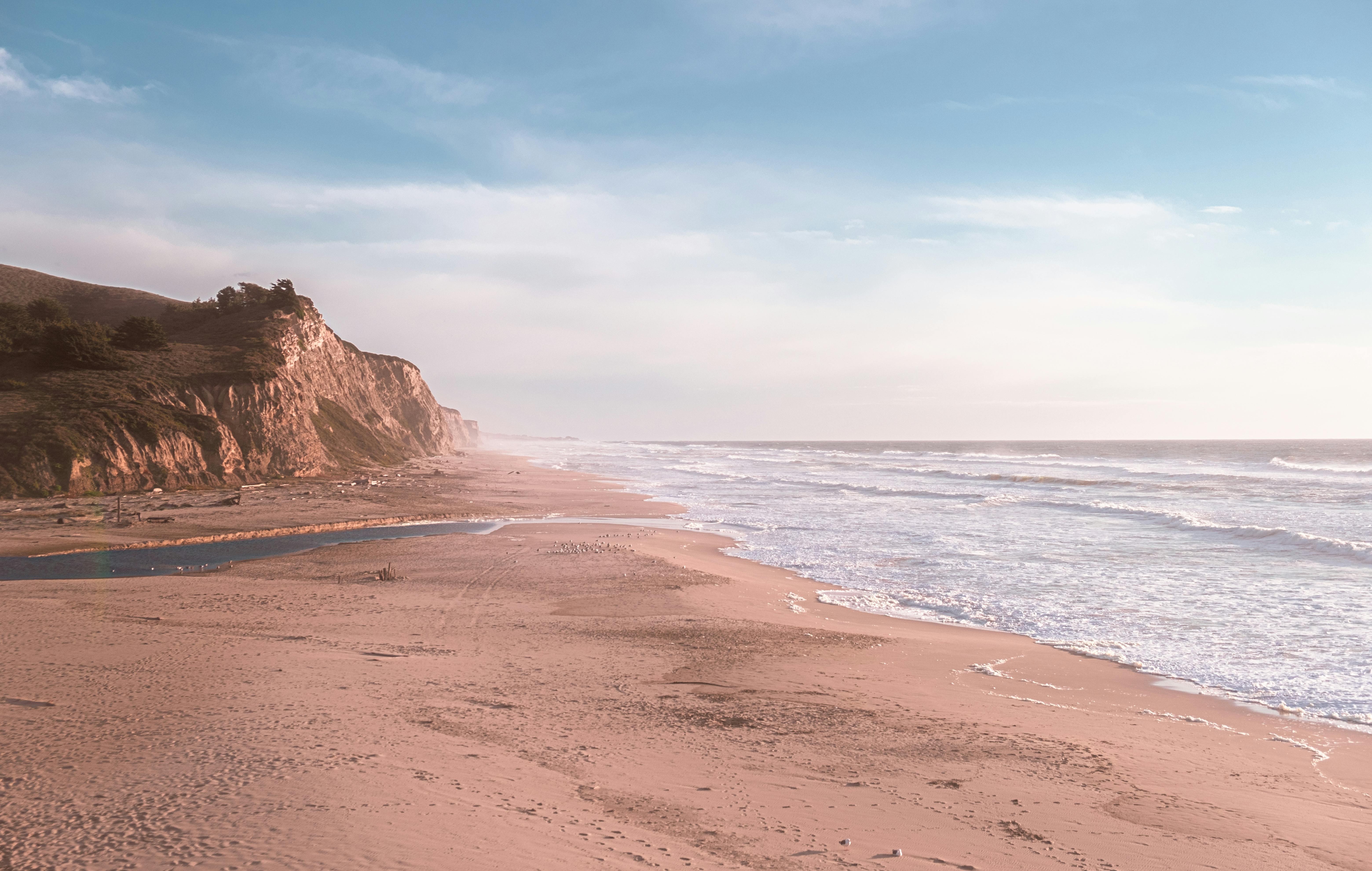 View of a Beach, Cliff and the Sea · Free Stock Photo