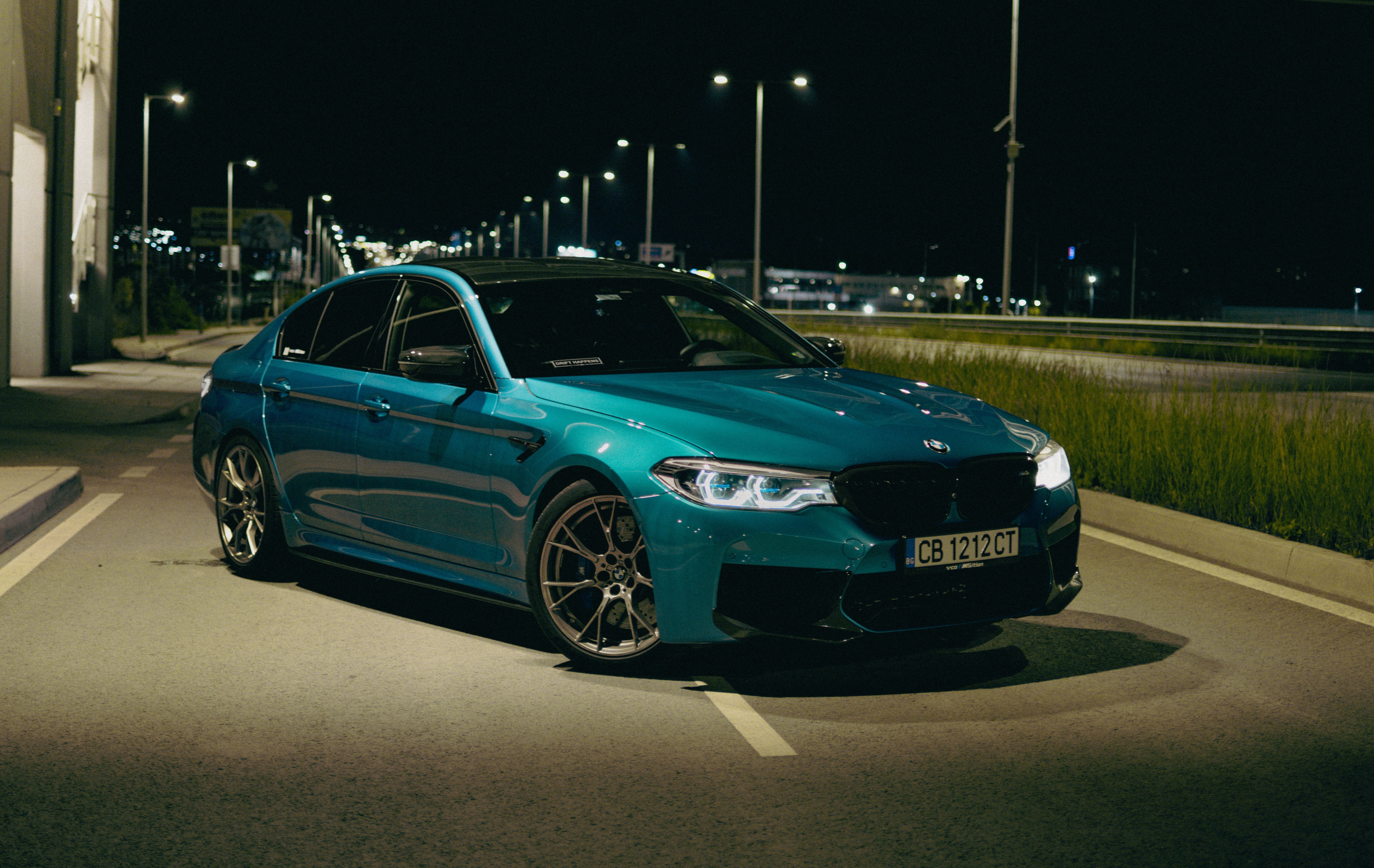 A Blue BMW M5 Parked on a Street at Night · Free Stock Photo