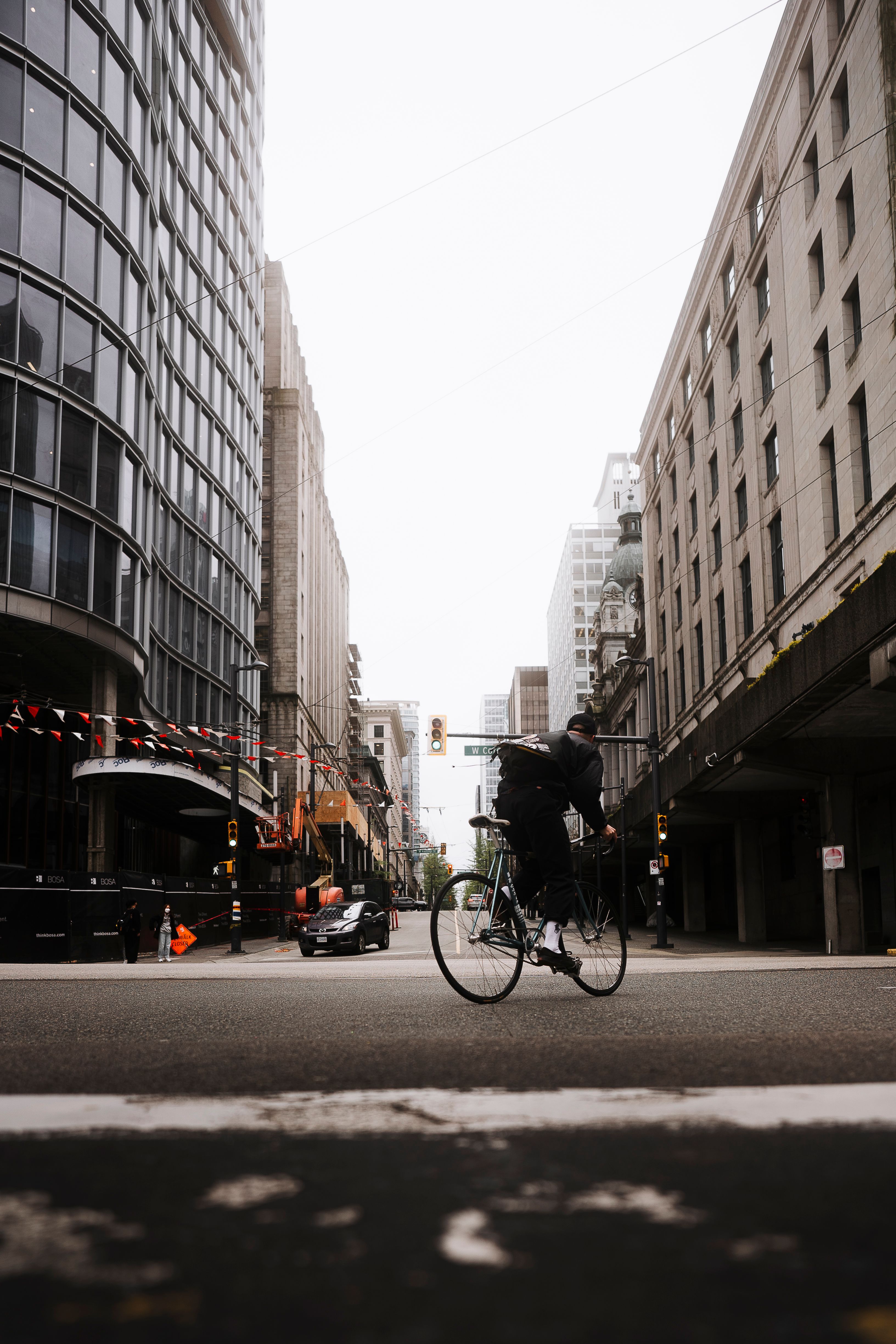 Man Riding on Bicycle on City Street · Free Stock Photo