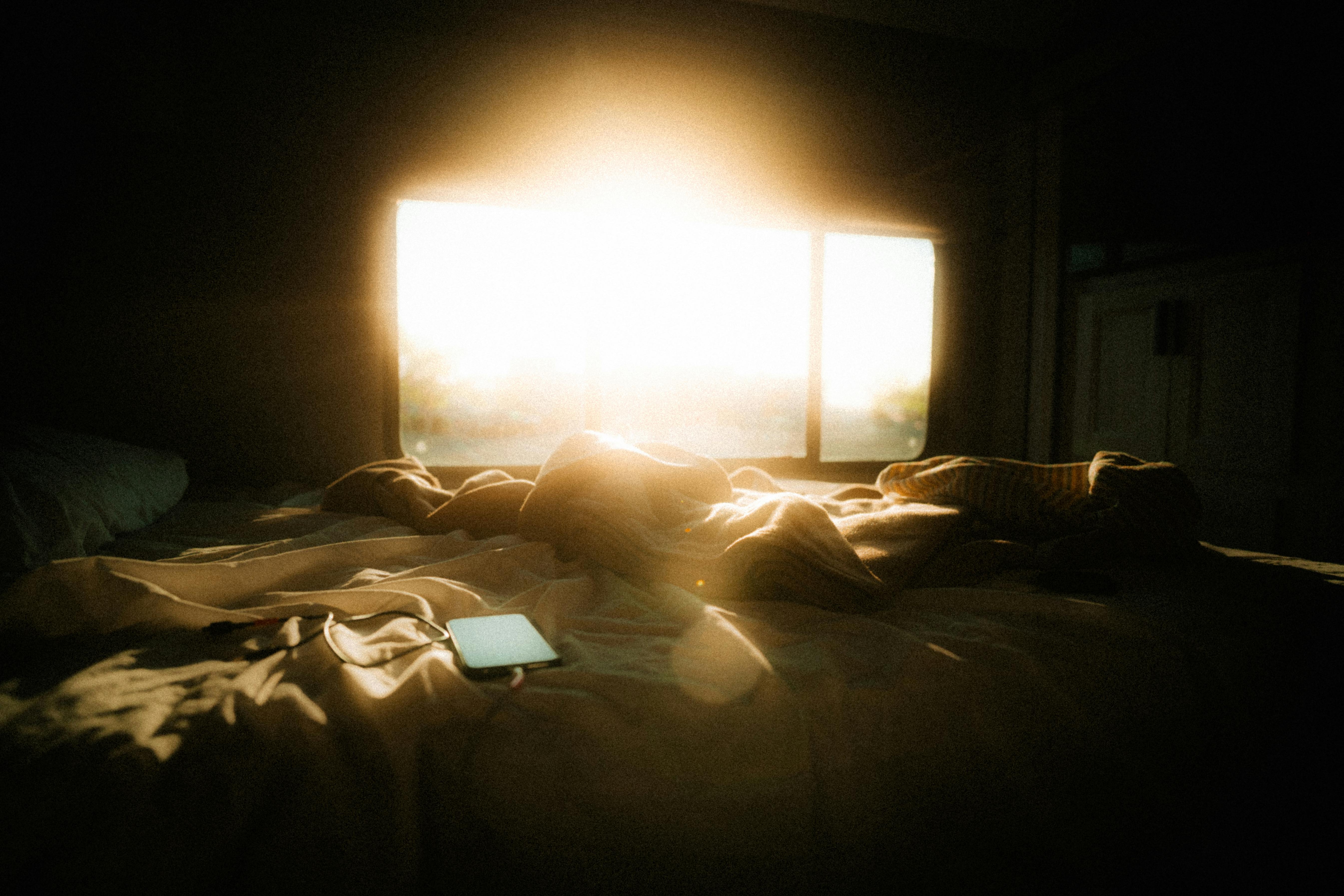 Bright Sunlight Shining through Window on a Messy Bed · Free Stock Photo