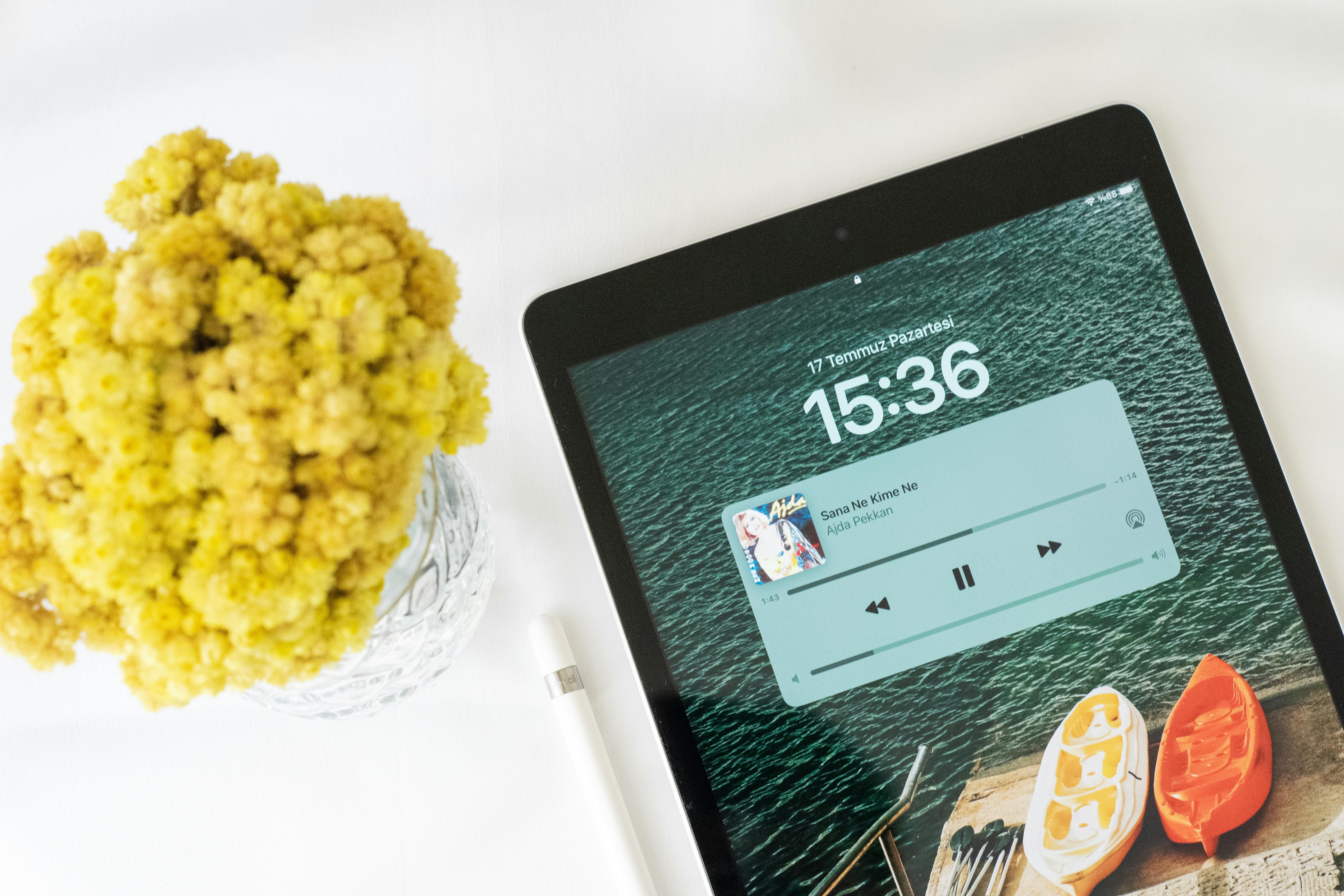 Blooming Flowers and Tablet on Table · Free Stock Photo