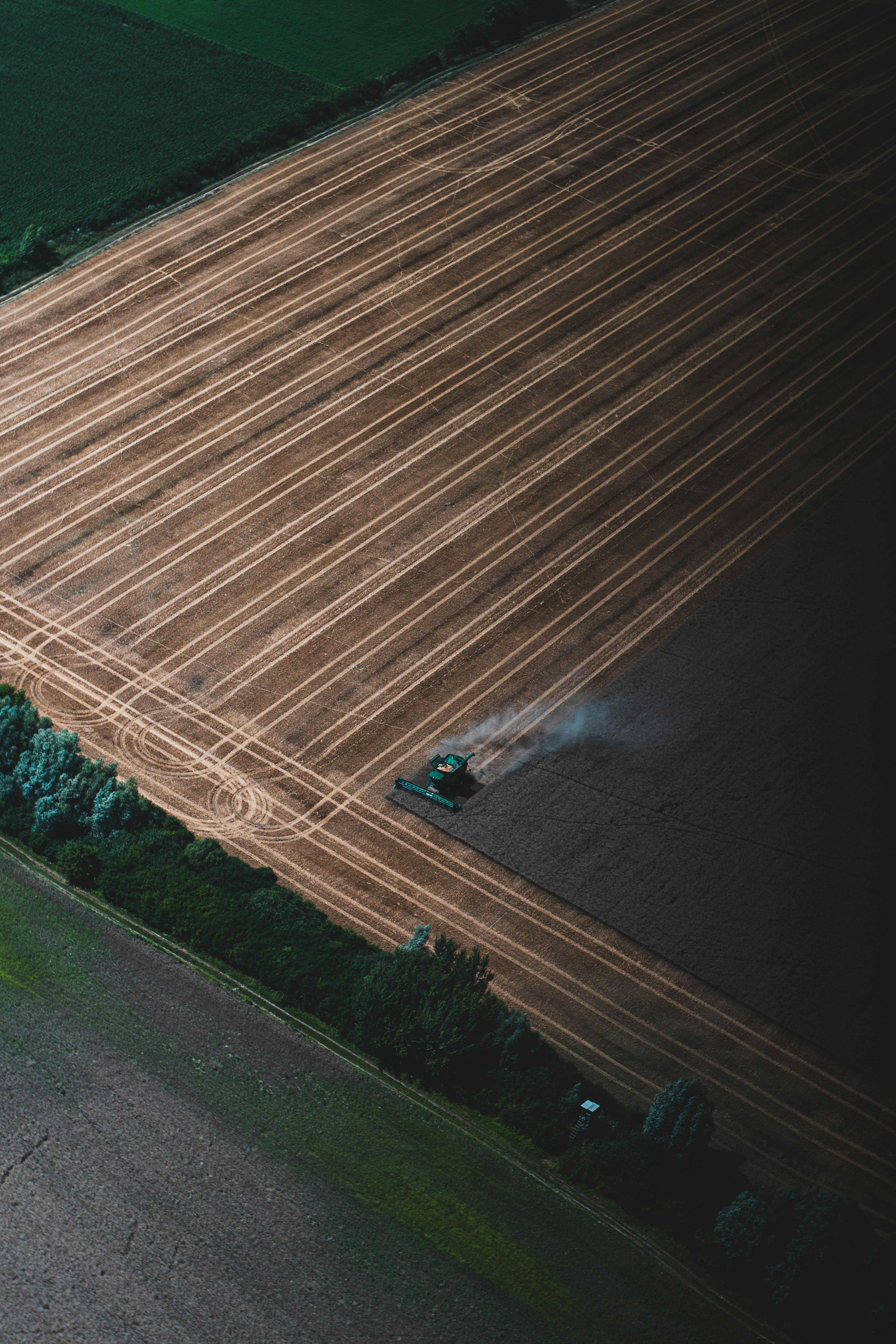 Working combine in the field from above · Free Stock Photo