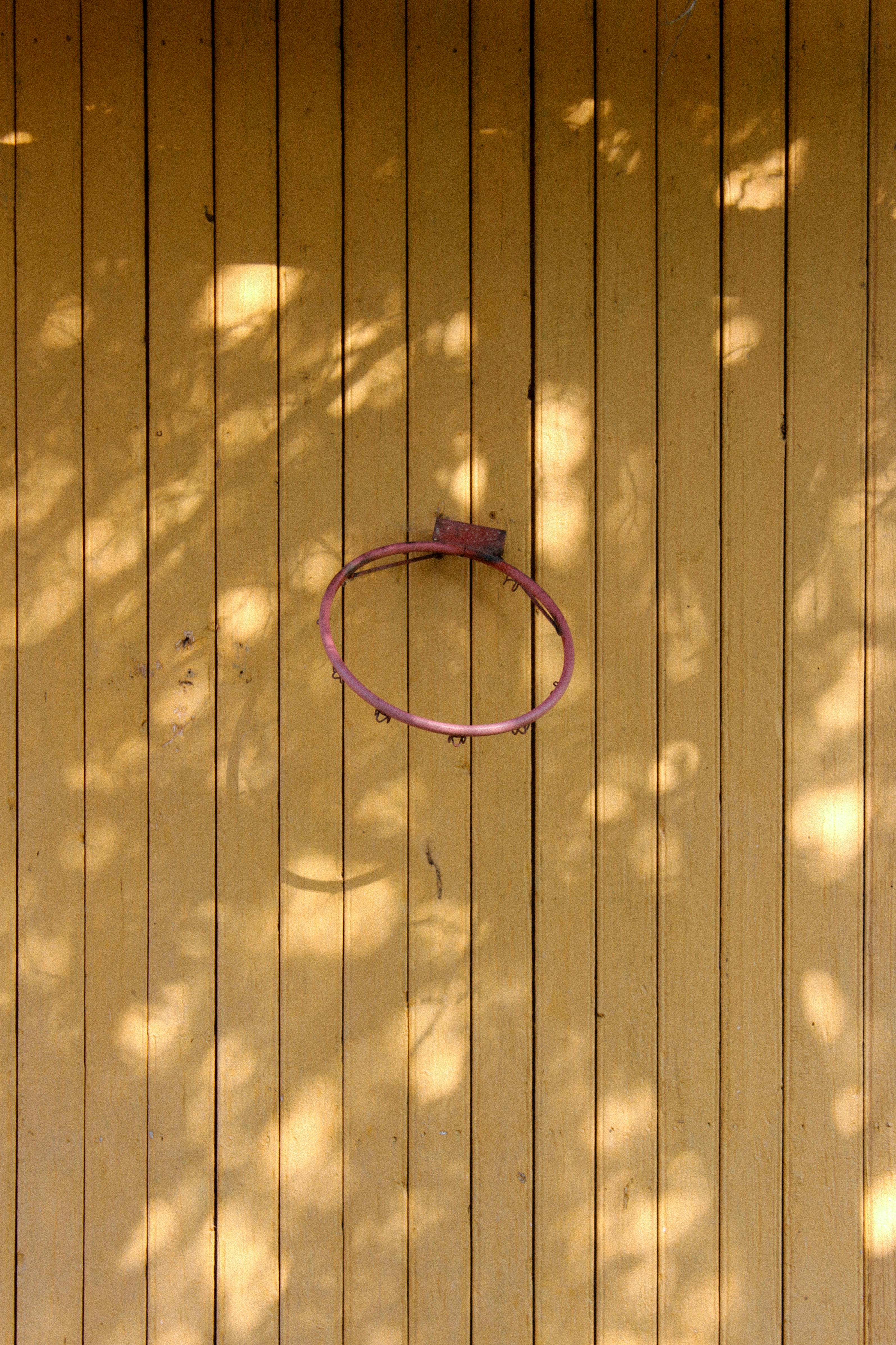 Basketball Hoop without Net on Wooden Wall · Free Stock Photo