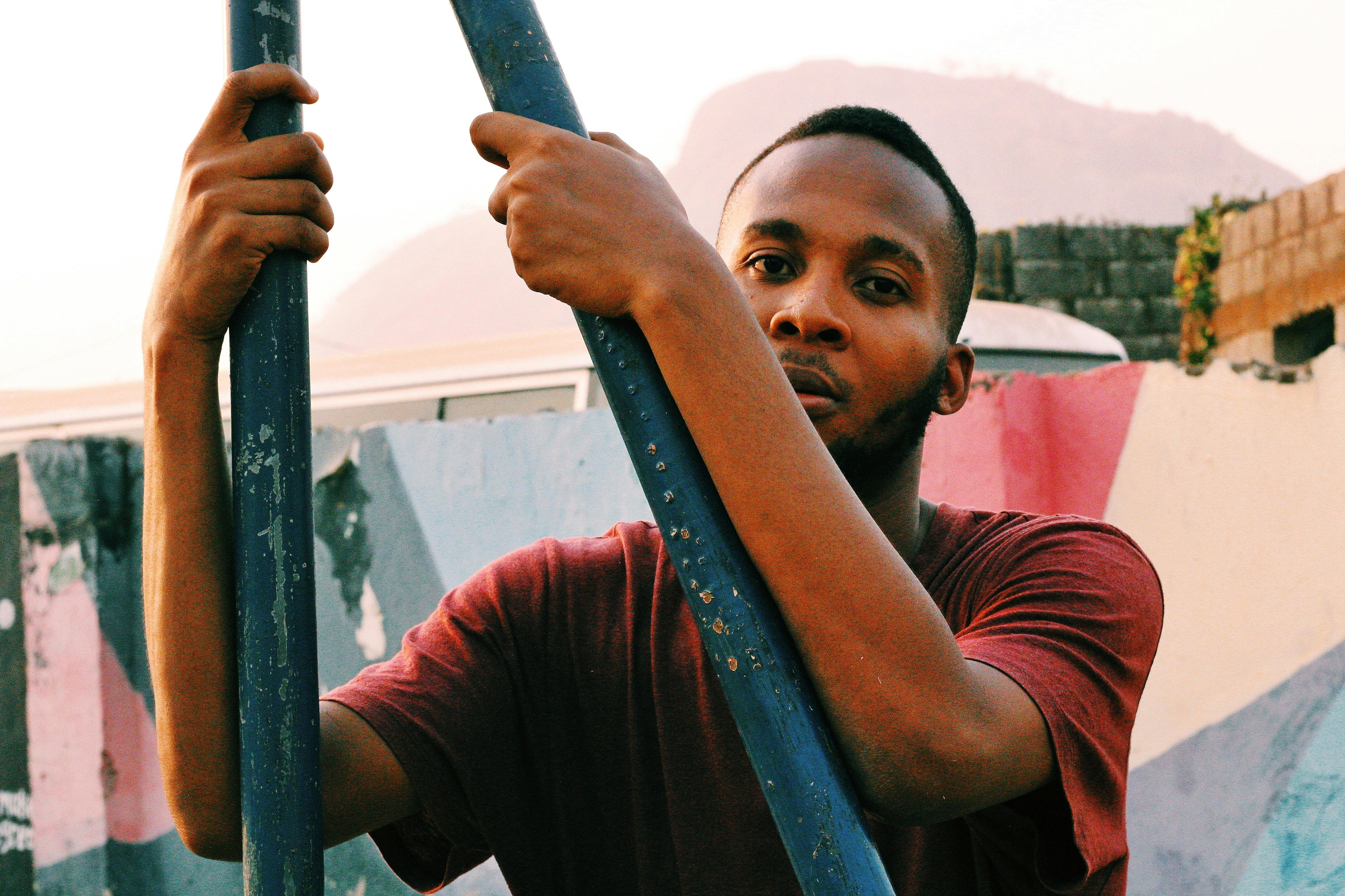 Man Holding Bars · Free Stock Photo