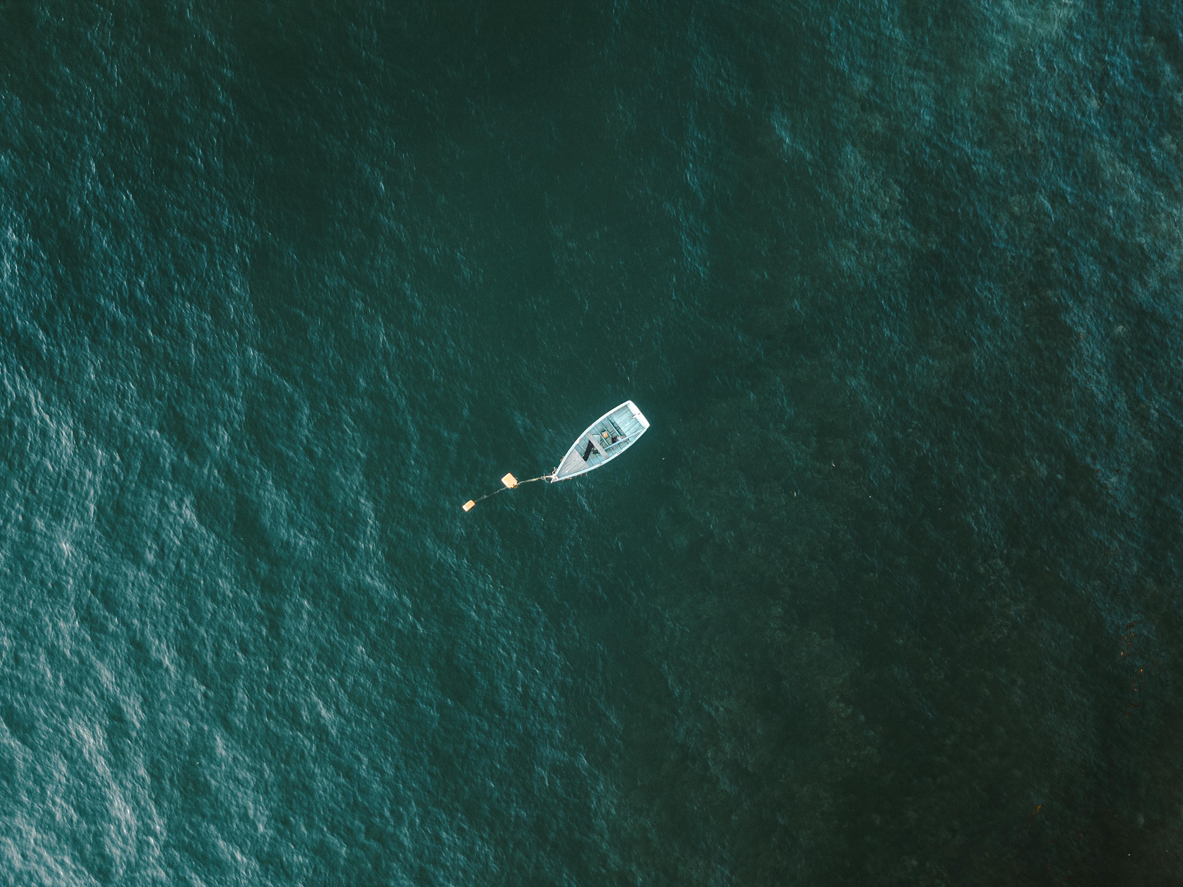Boat Anchored in the middle of Sea · Free Stock Photo