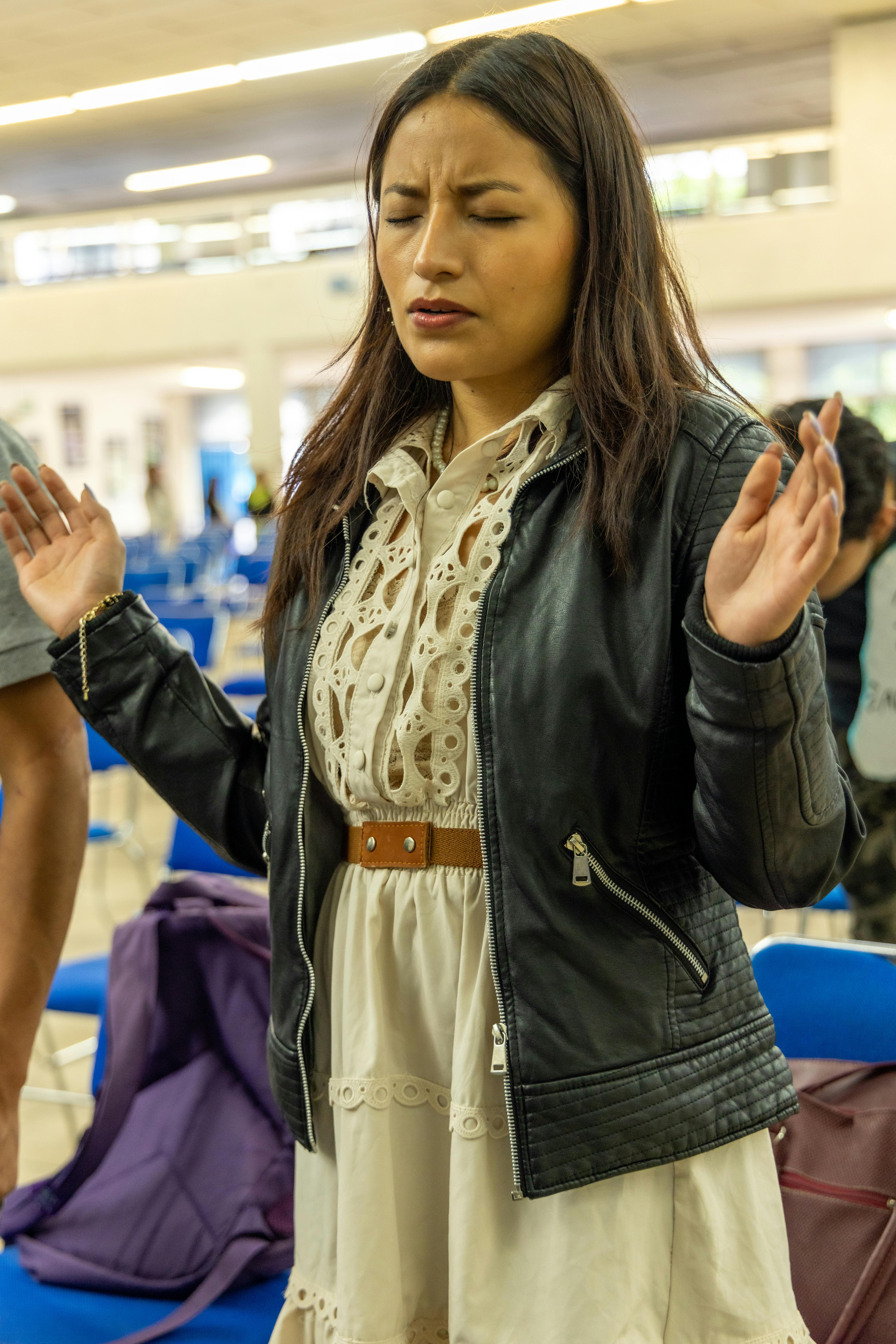 Young Brunette Woman in Leather Jacket Praying · Free Stock Photo
