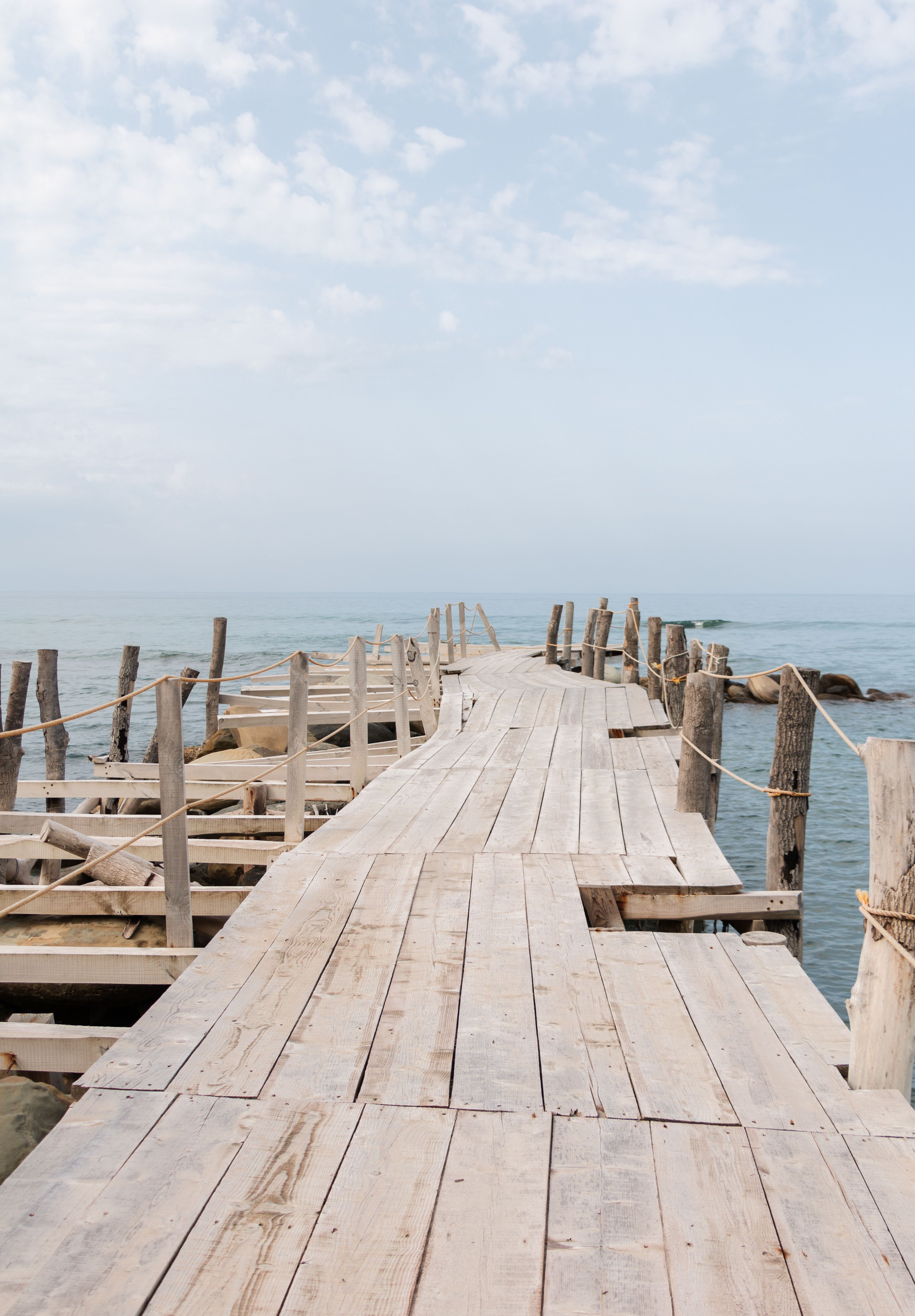 A Crooked Wooden Pier Leading to the Sea · Free Stock Photo