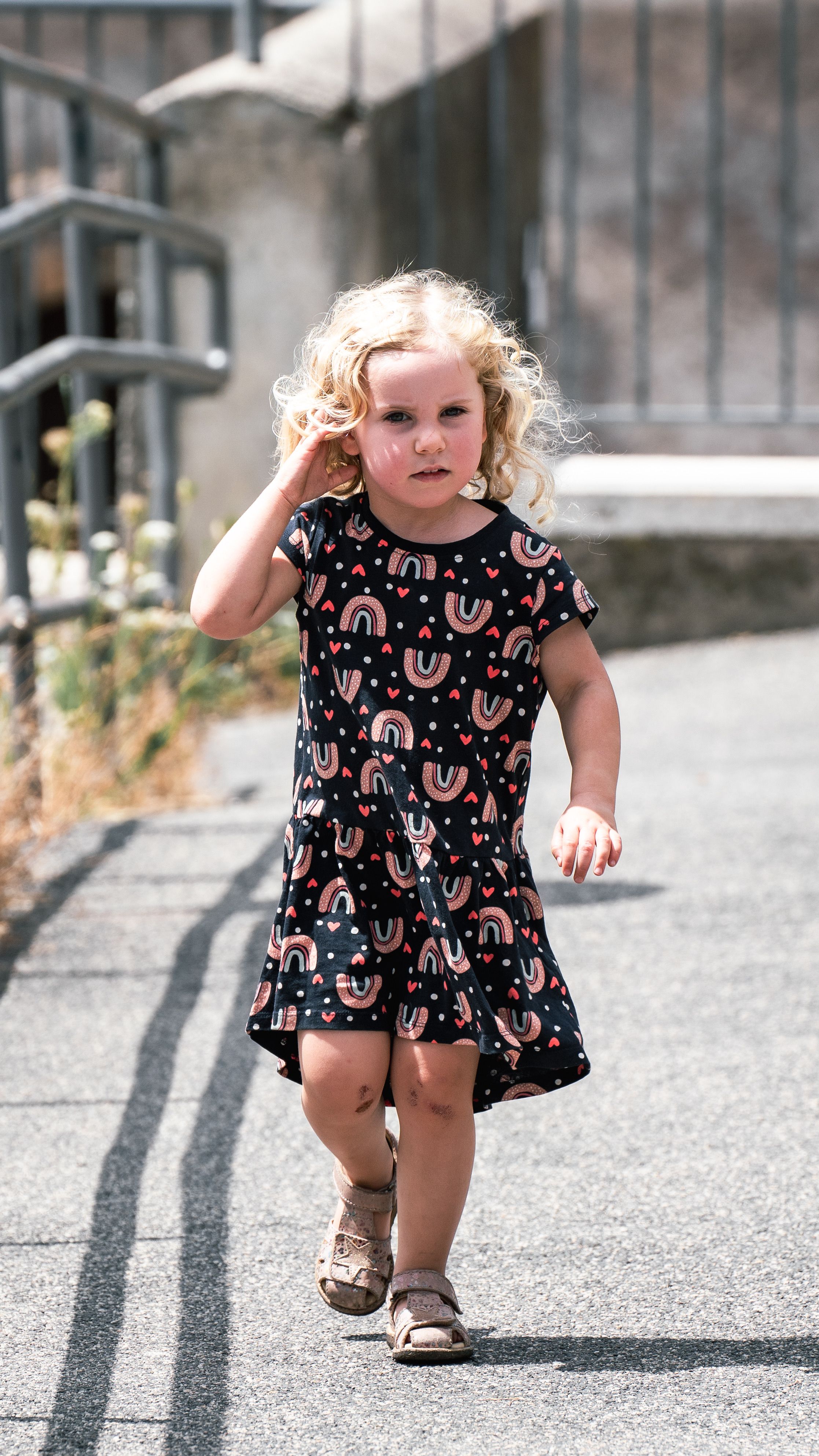 Blonde Girl in Sundress Walking on Sunlit Road · Free Stock Photo