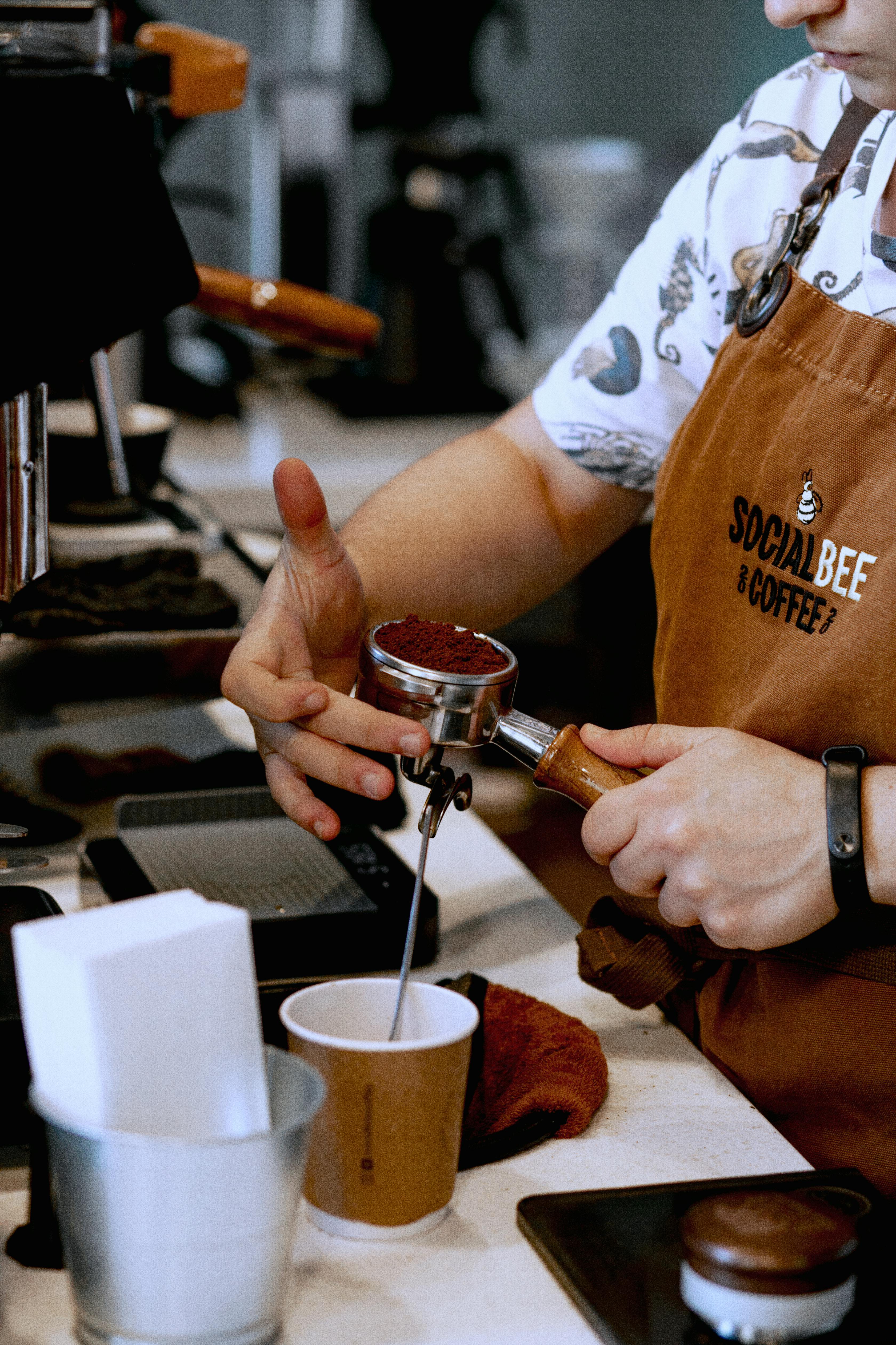 A Man in Black Shirt Making Coffee while Holding a Portafilter · Free ...
