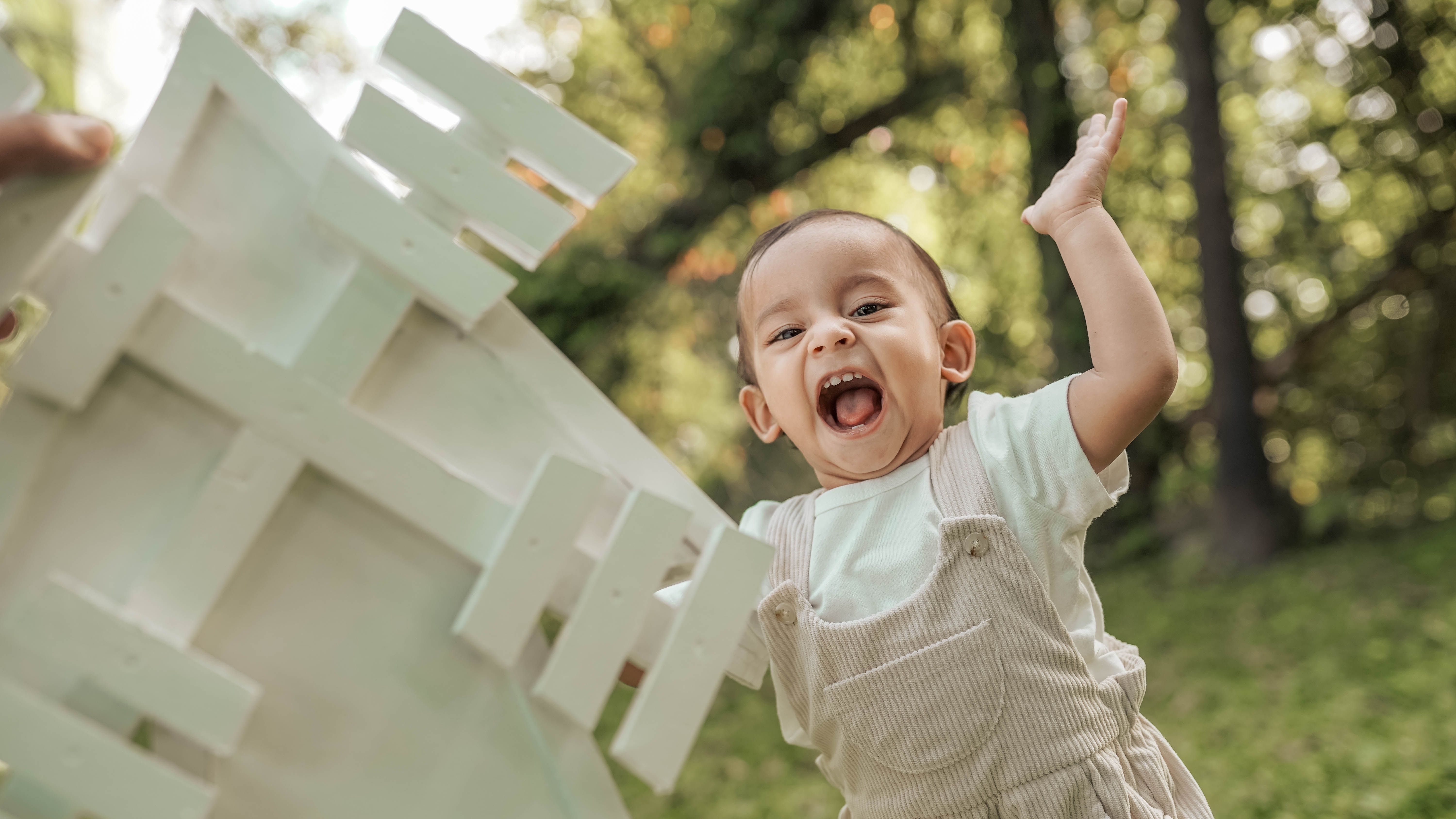 Happy Toddler Playing with a Decorative Windmill · Free Stock Photo