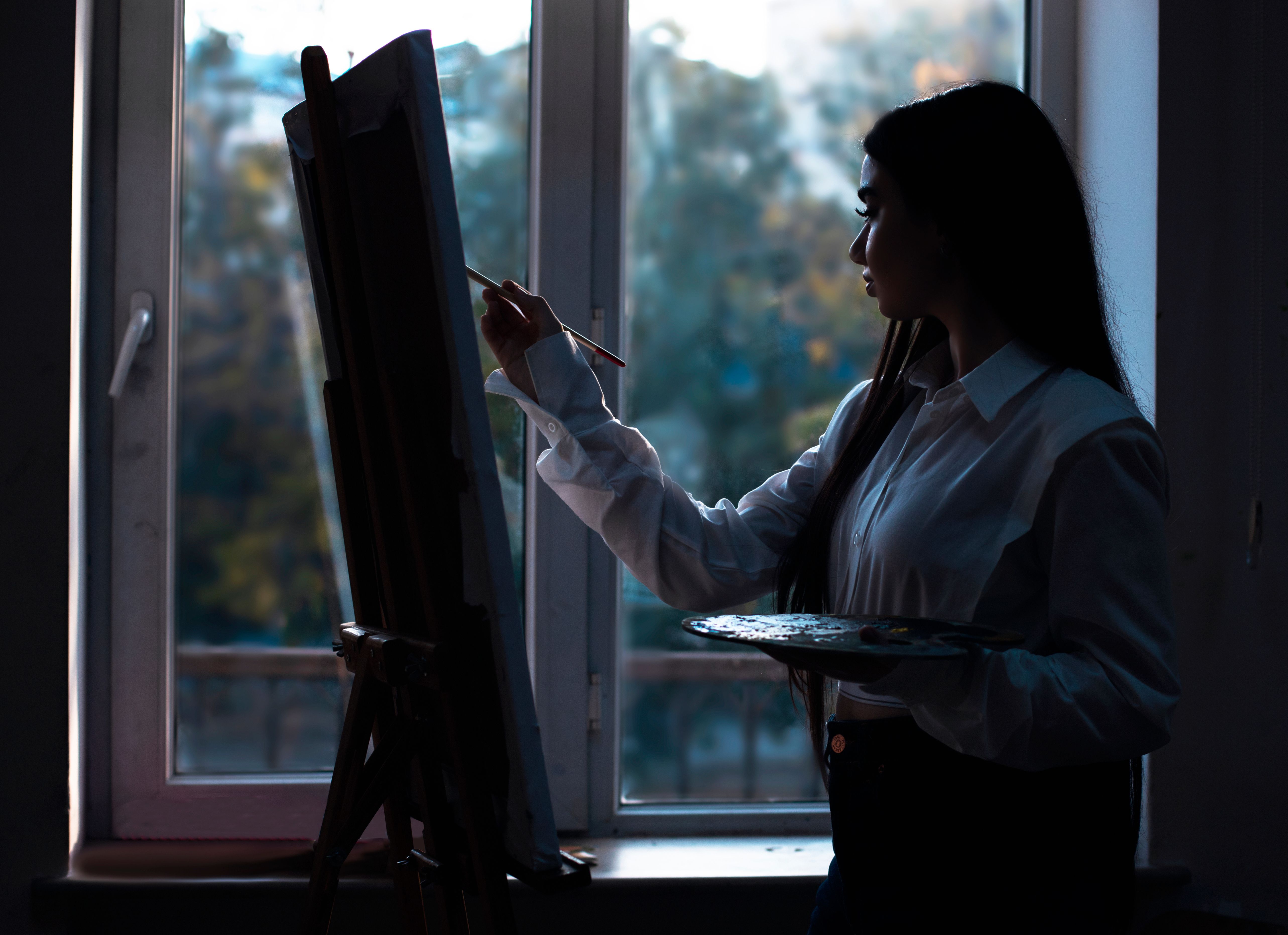 Woman Painting on Canvas by Window · Free Stock Photo