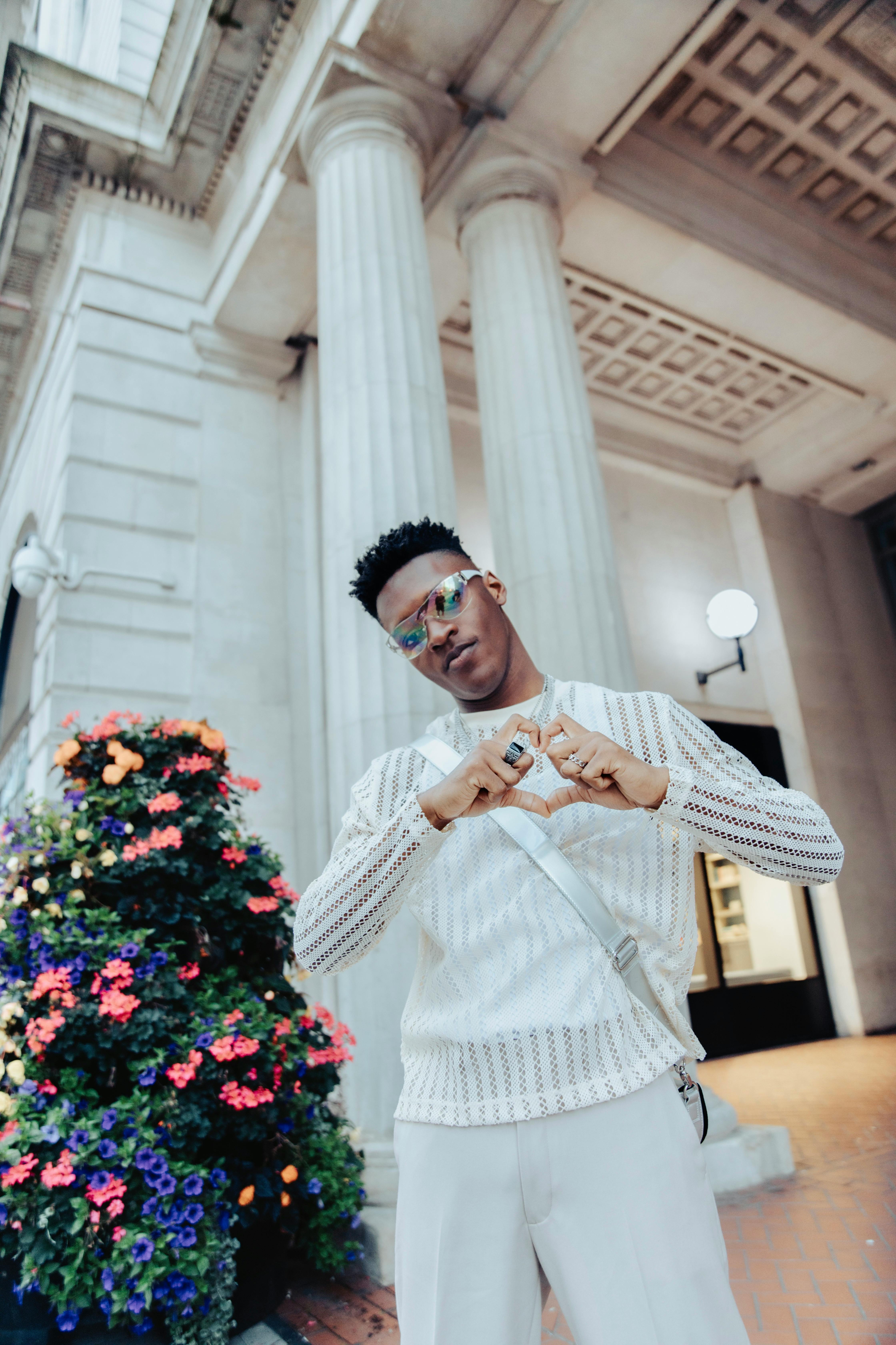 Portrait of a Male Model Making a Heart Shape with Hands · Free Stock Photo