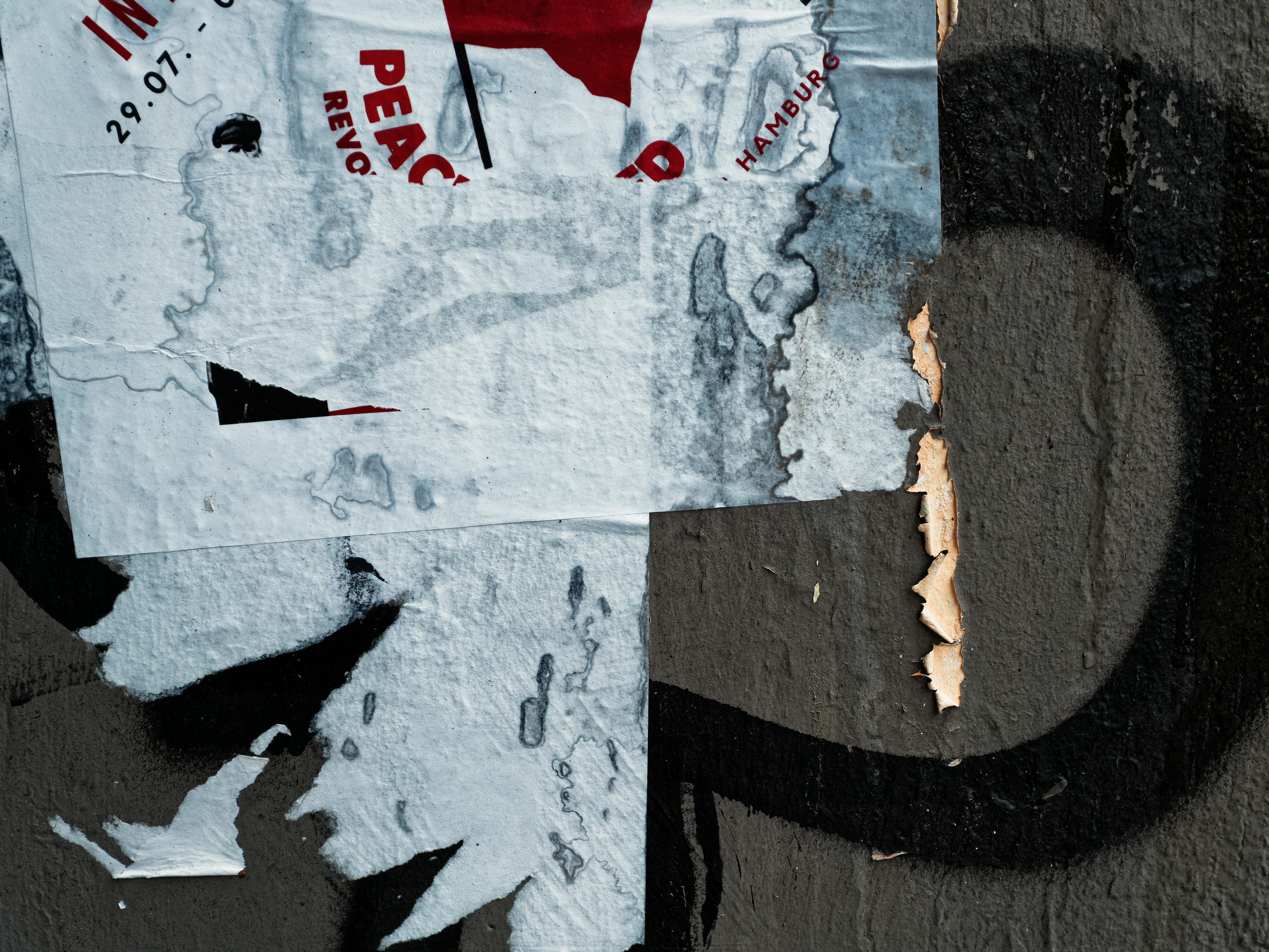 Remnants of Torn Posters on the Wall · Free Stock Photo