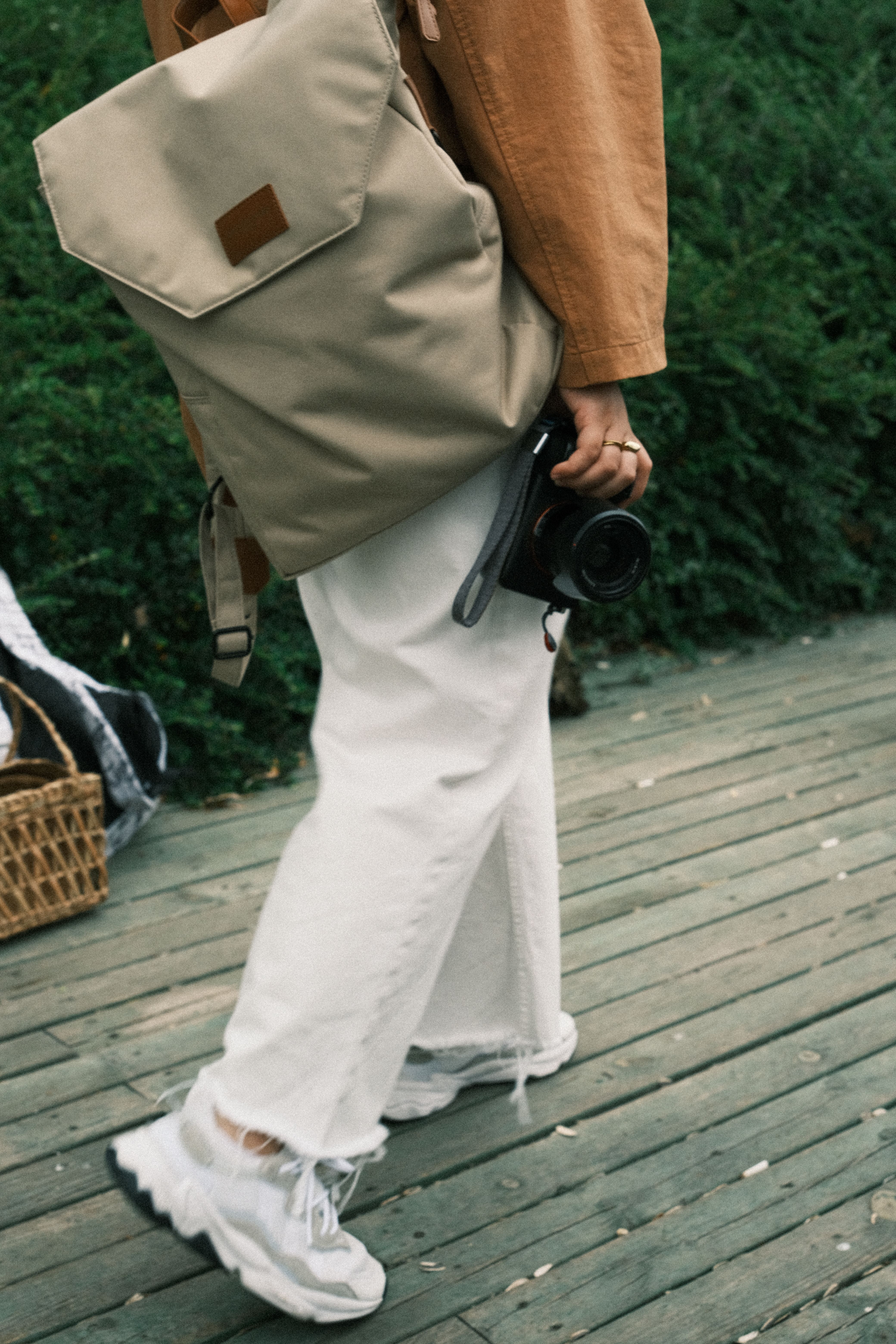 Close up of Person Walking with Camera and Backpack · Free Stock Photo