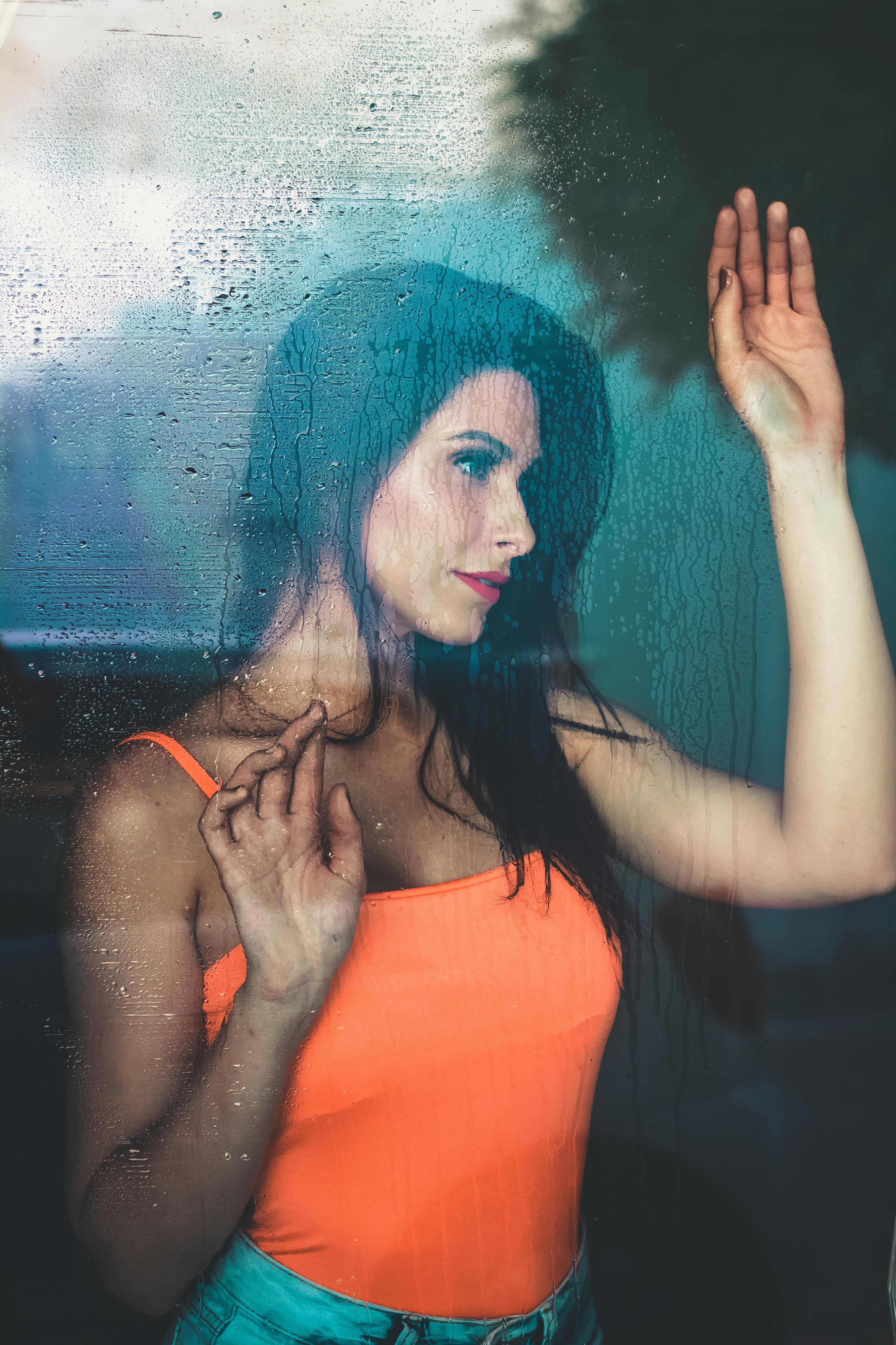 Photo of Woman Leaning Against Window Looking Outside · Free Stock Photo