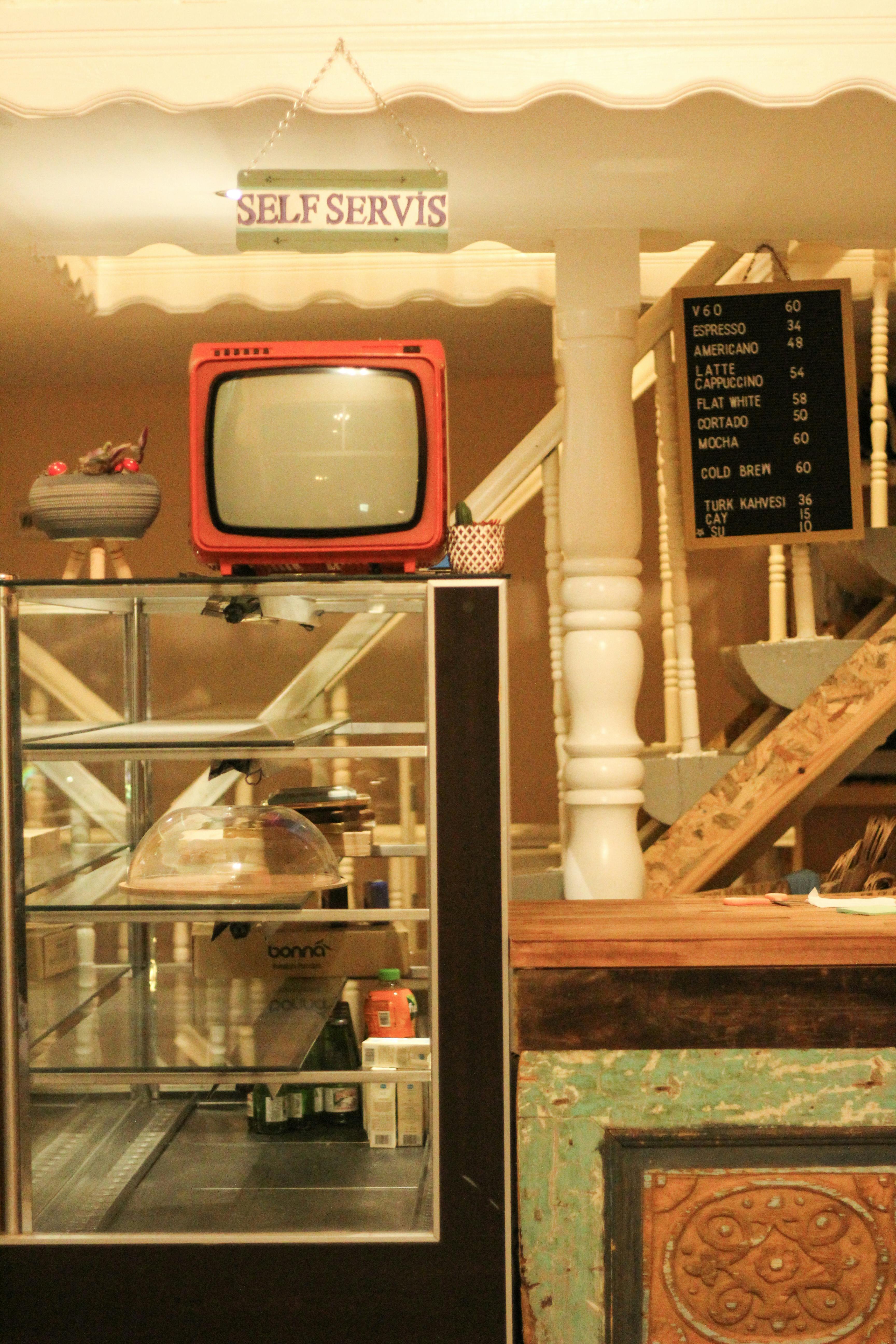 Cafe with Hanging Menu and Vintage TV Set · Free Stock Photo