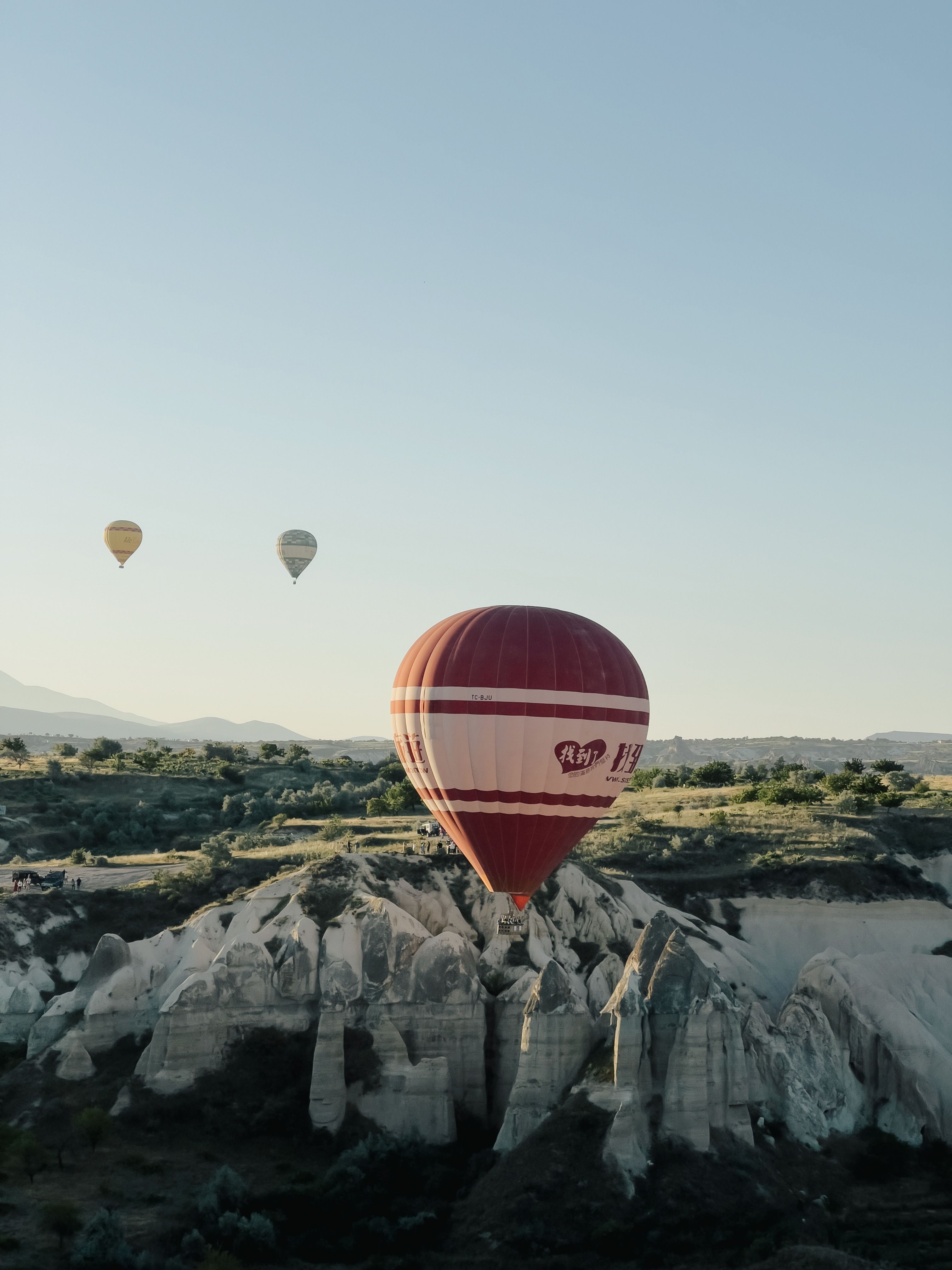 Balloons Floating over Rocky Landscape in Cappadocia · Free Stock Photo