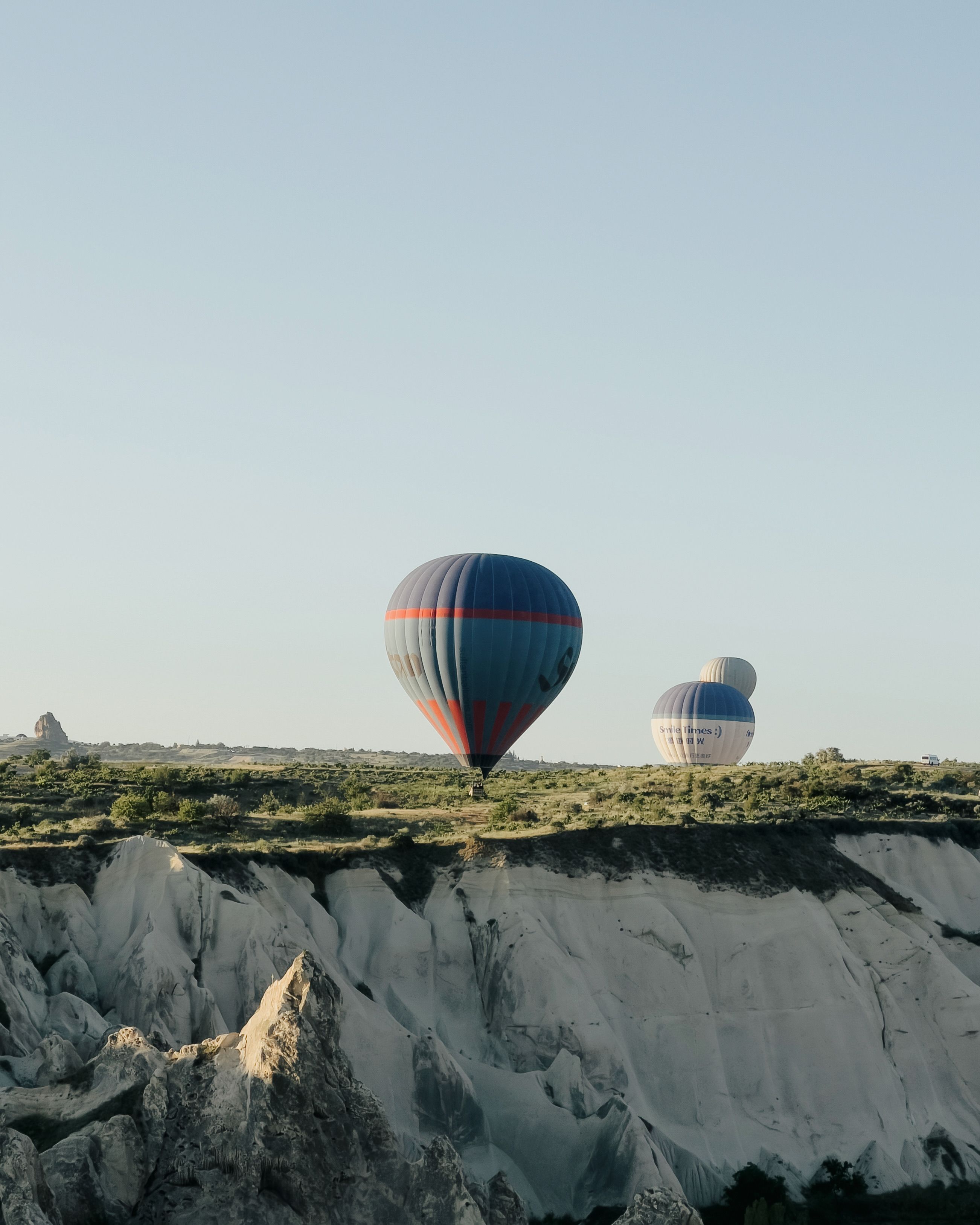 Balloons Floating over Rocky Landscape in Cappadocia · Free Stock Photo