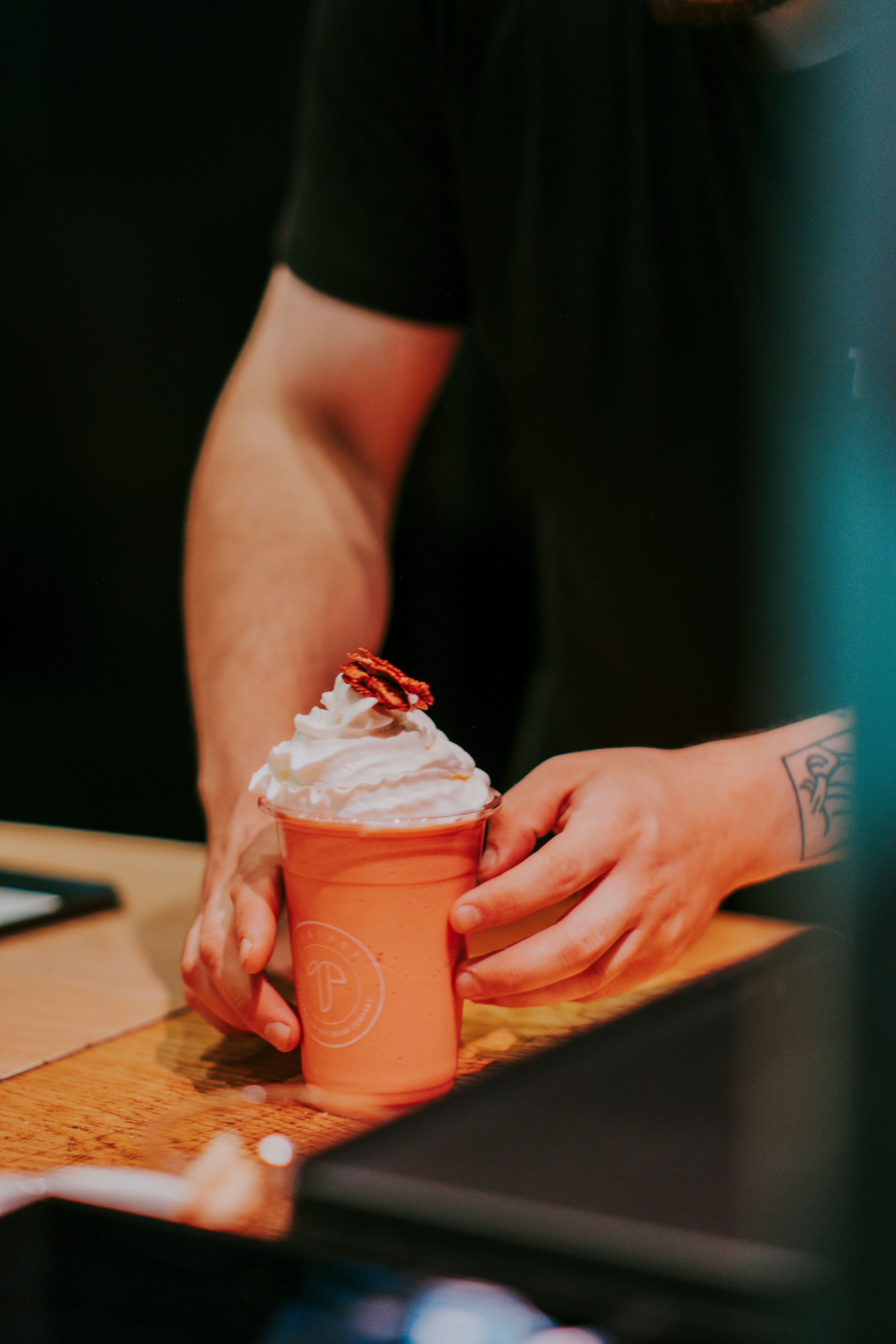A Person Taking a Cup with a Drink with Whipped Cream from the Counter ...