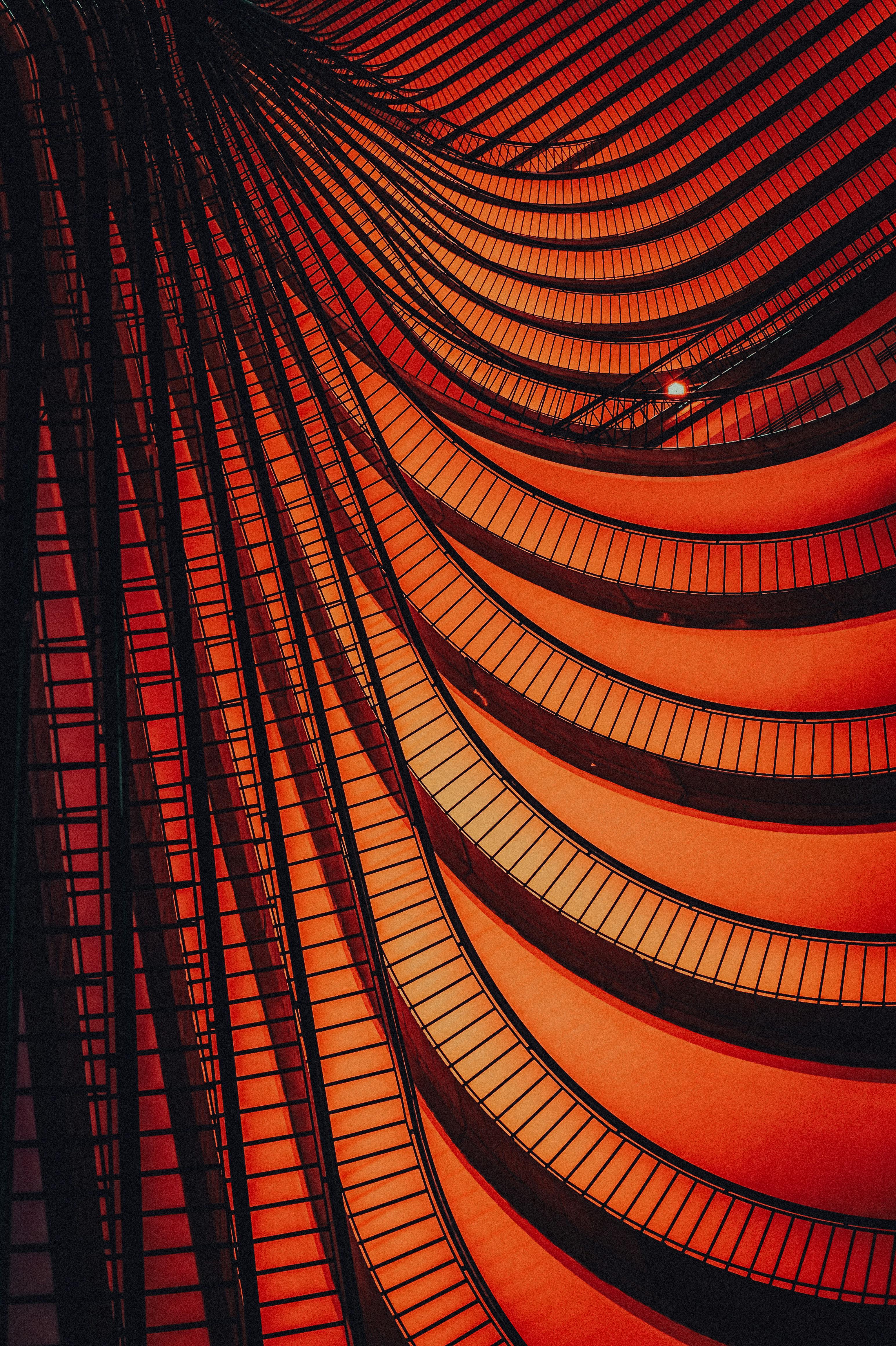 Surreal Overlapping Black Balconies on Red Wall · Free Stock Photo