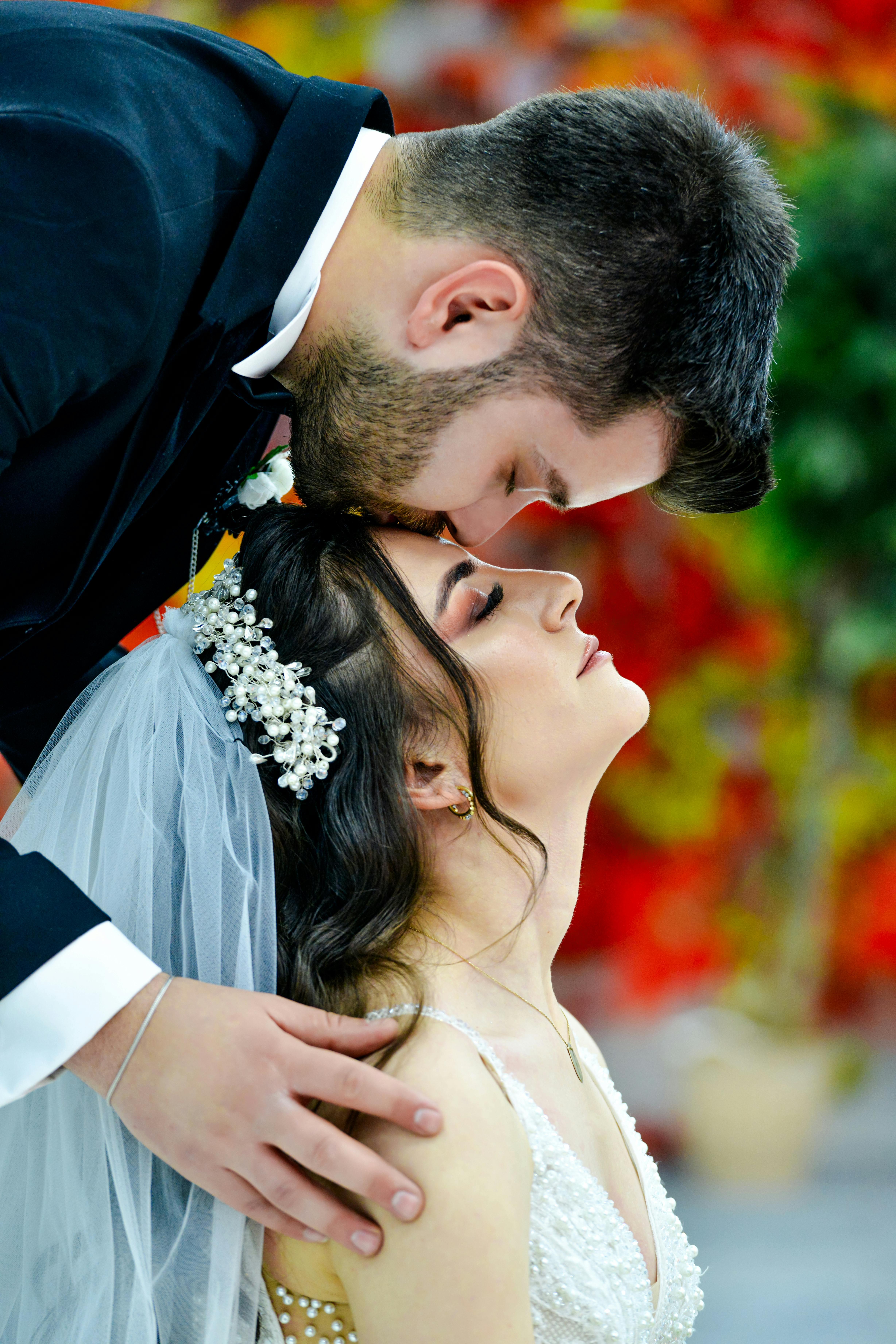 Groom Kissing the Bride on the Forehead · Free Stock Photo